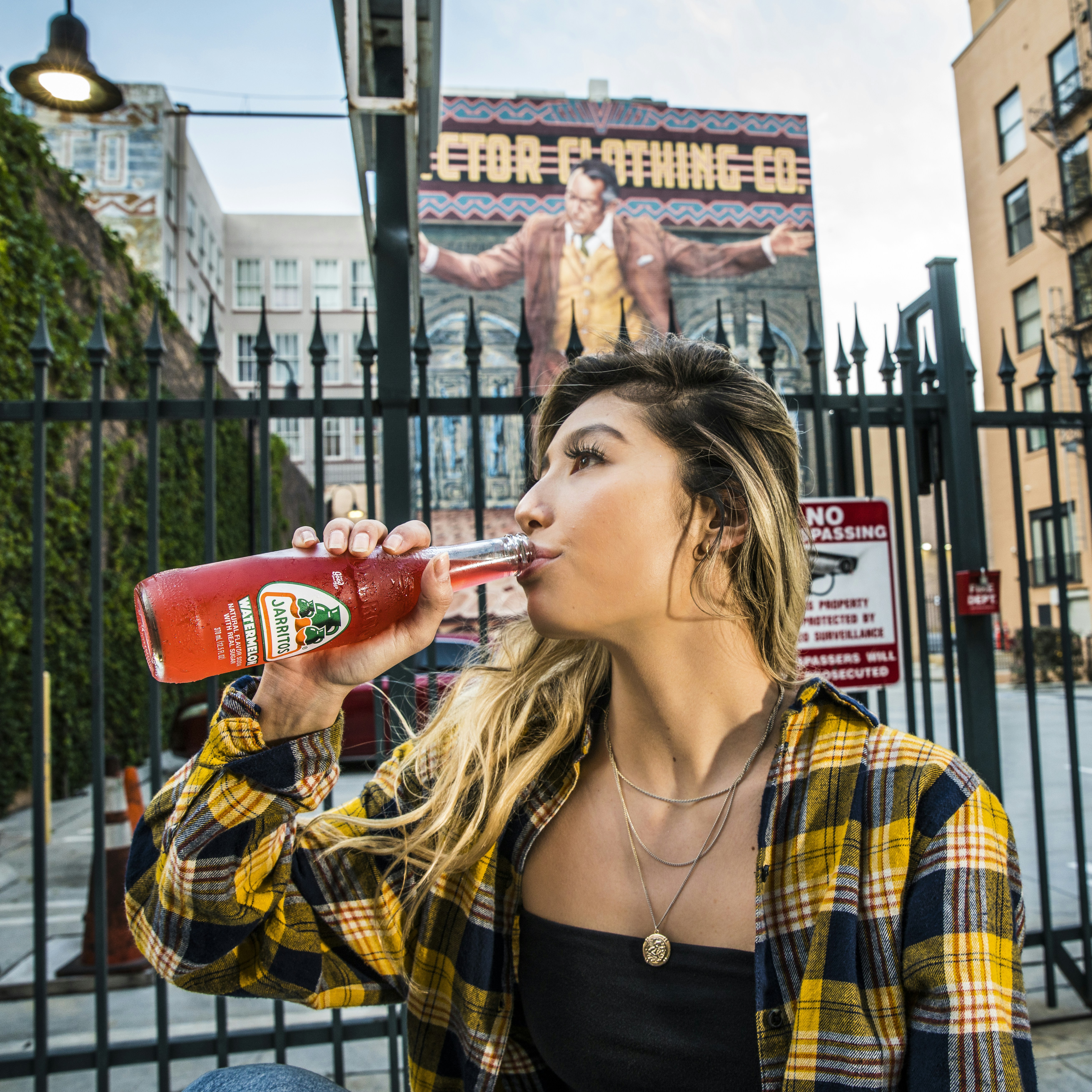 Plaid Portrait by the Mural Gate: Sipping Red in an Urban Frame