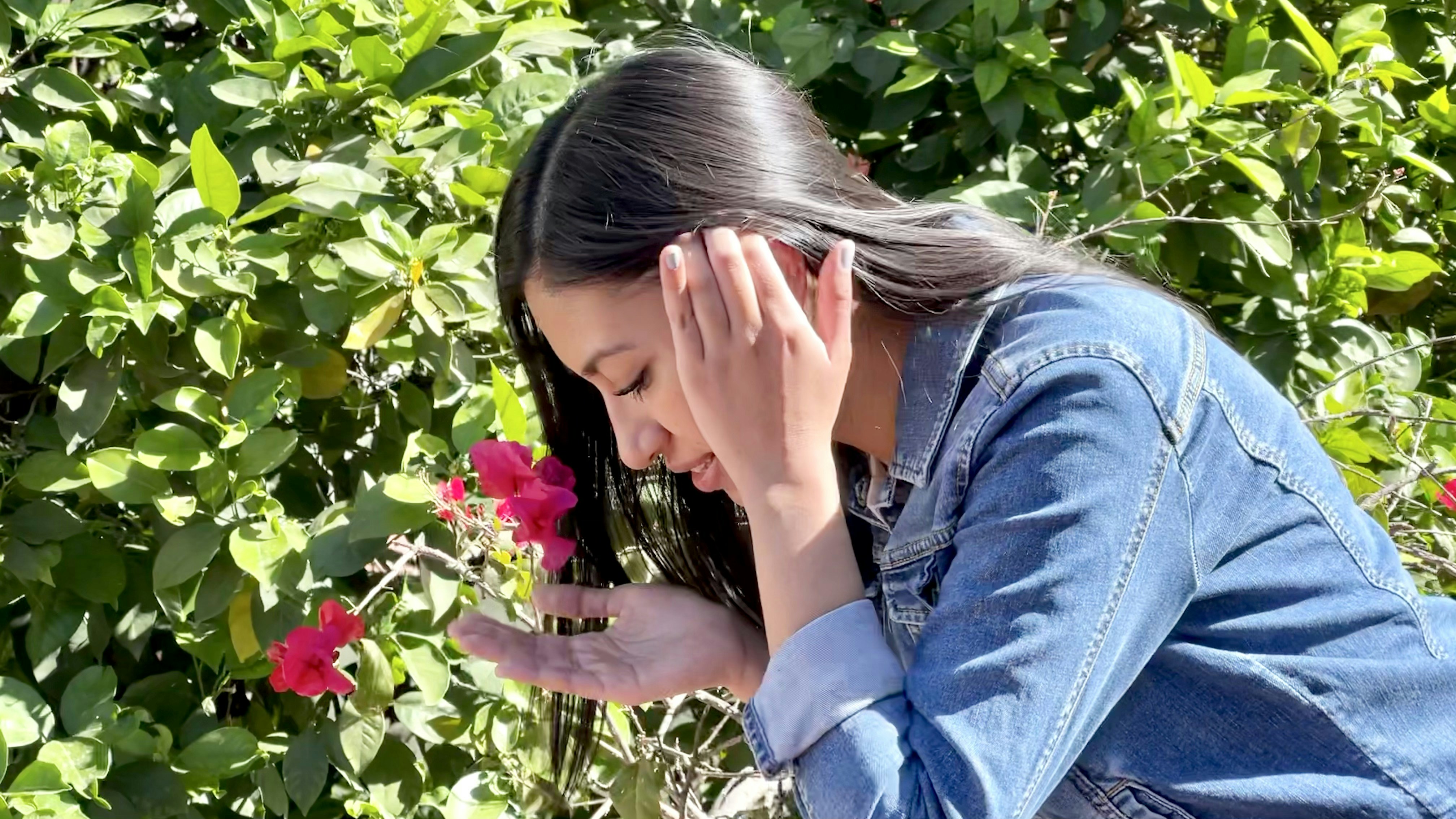 Girl admiring flower