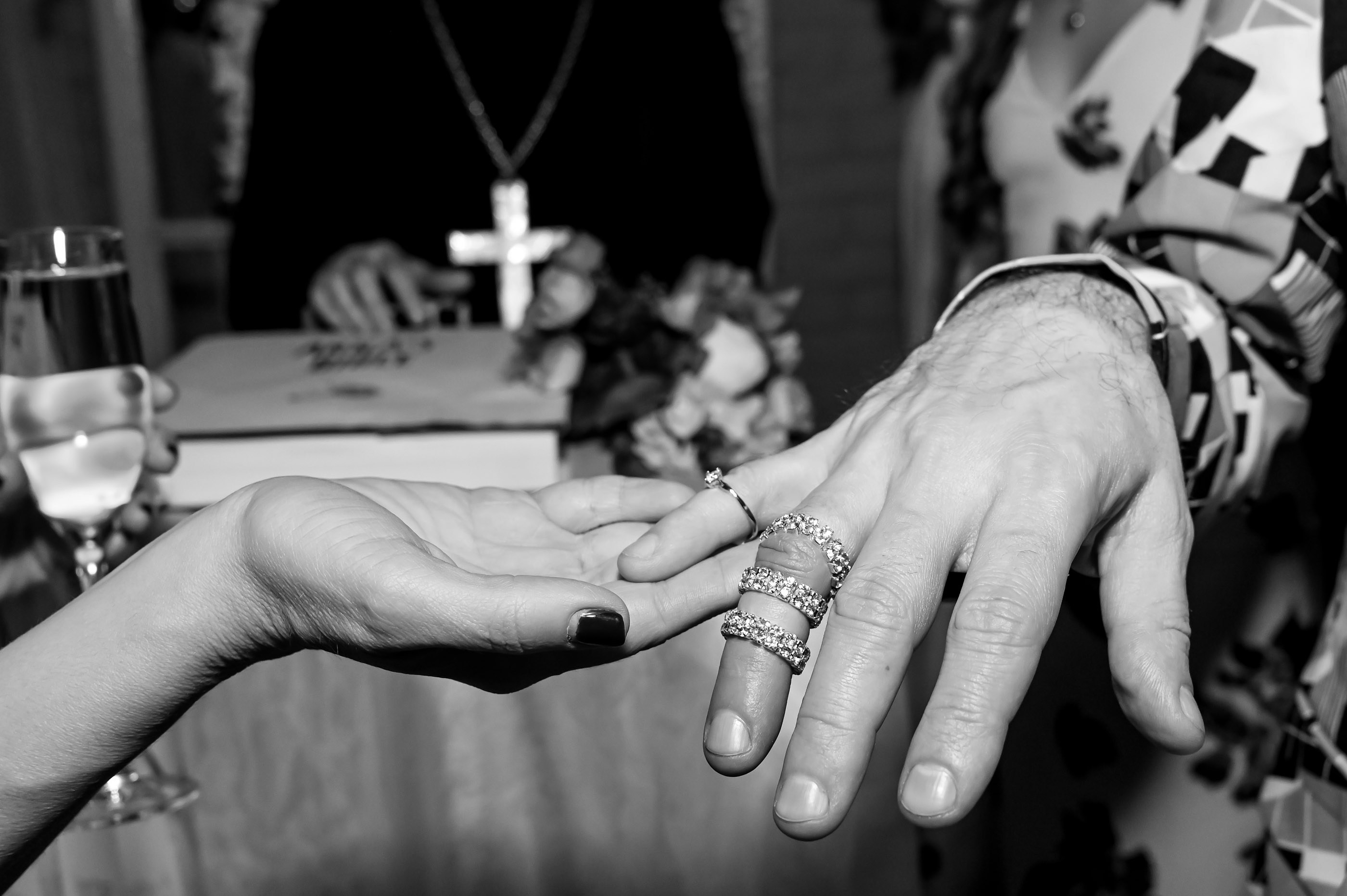 Man and woman holding hands, with rings on their fingers