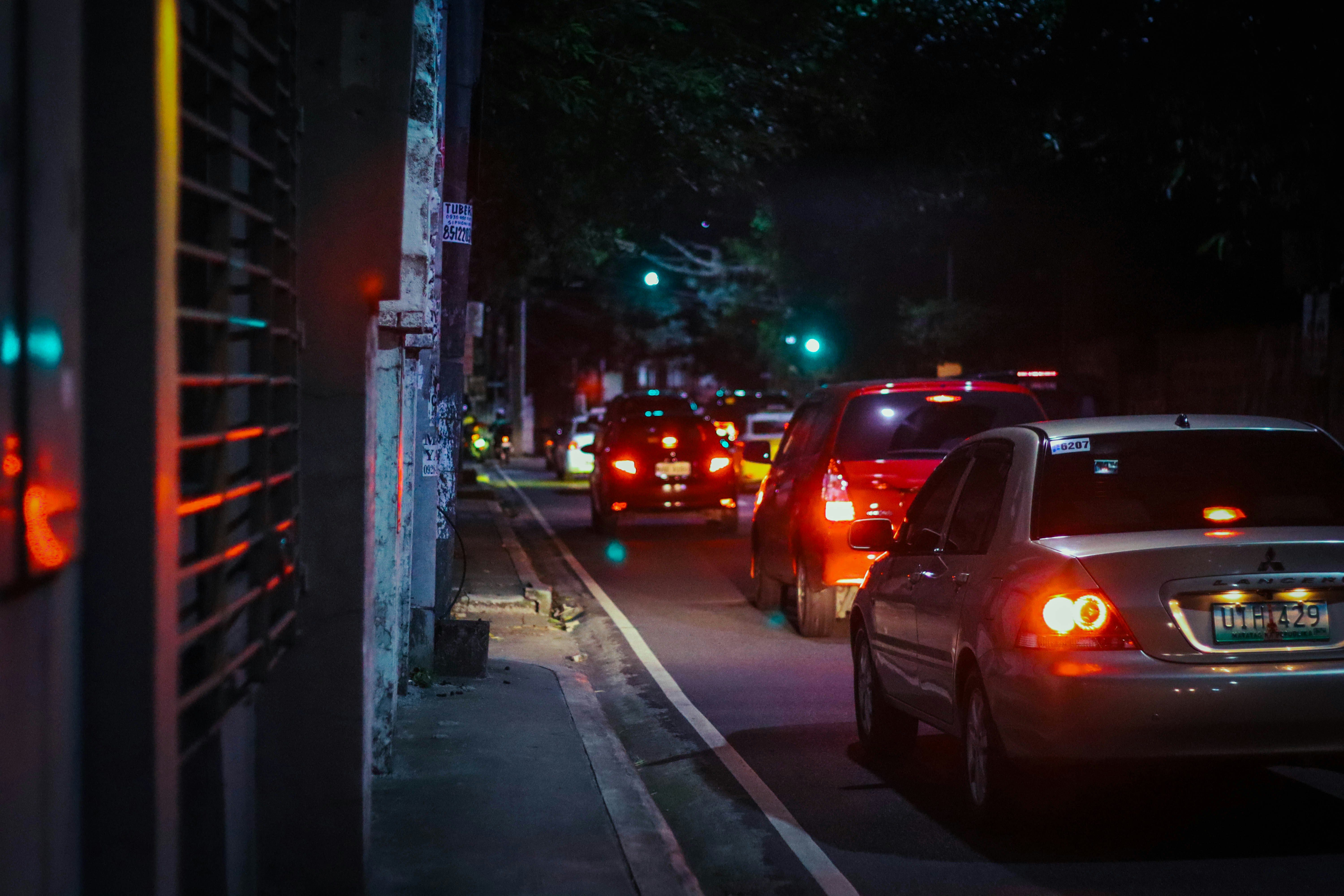Neon Convergence: Tail Lights on a Narrow Night Street