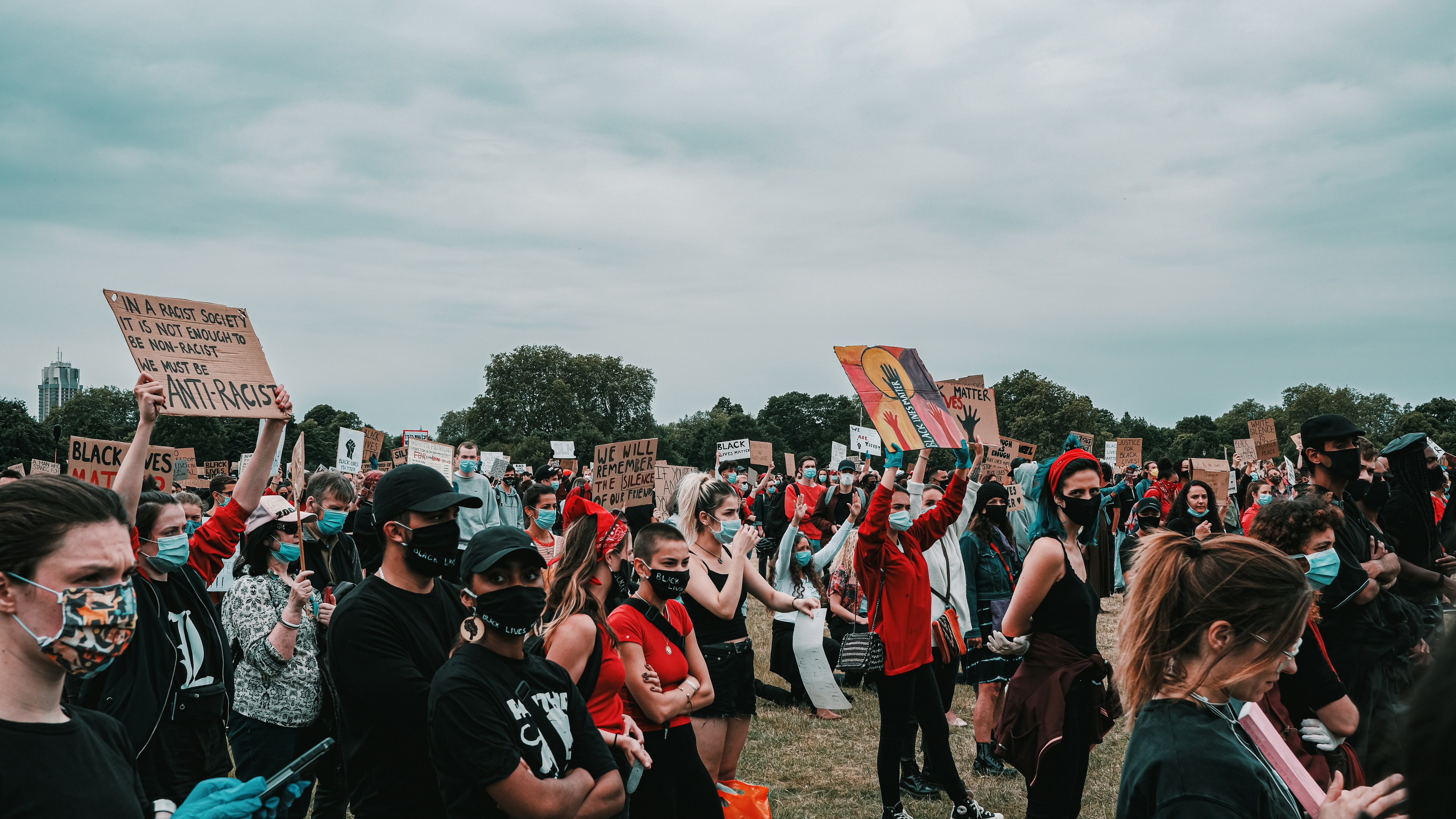 People in red and white shirts standing on green grass field during ...