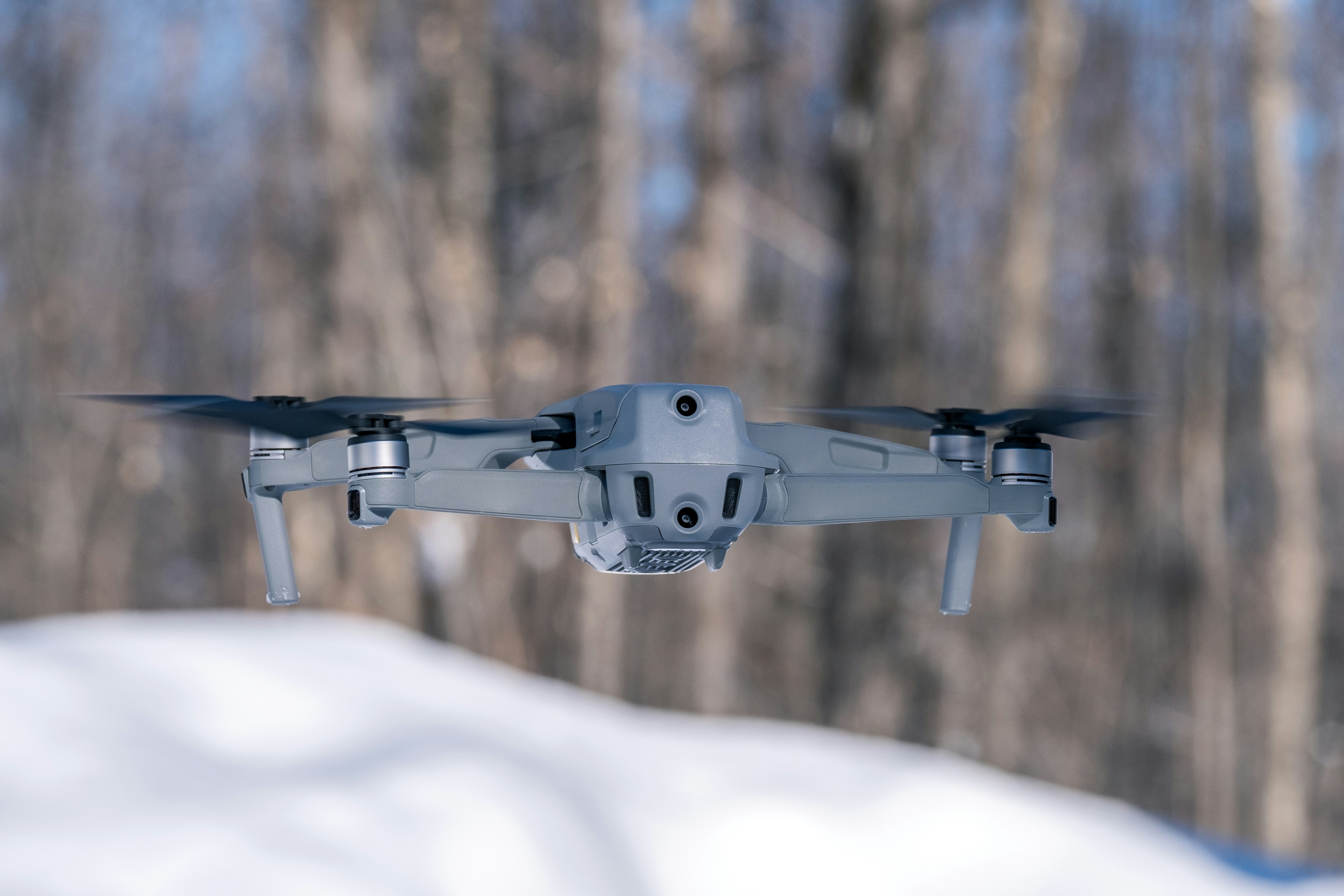 Gray drone flying over snow covered ground during daytime photo – Free ...