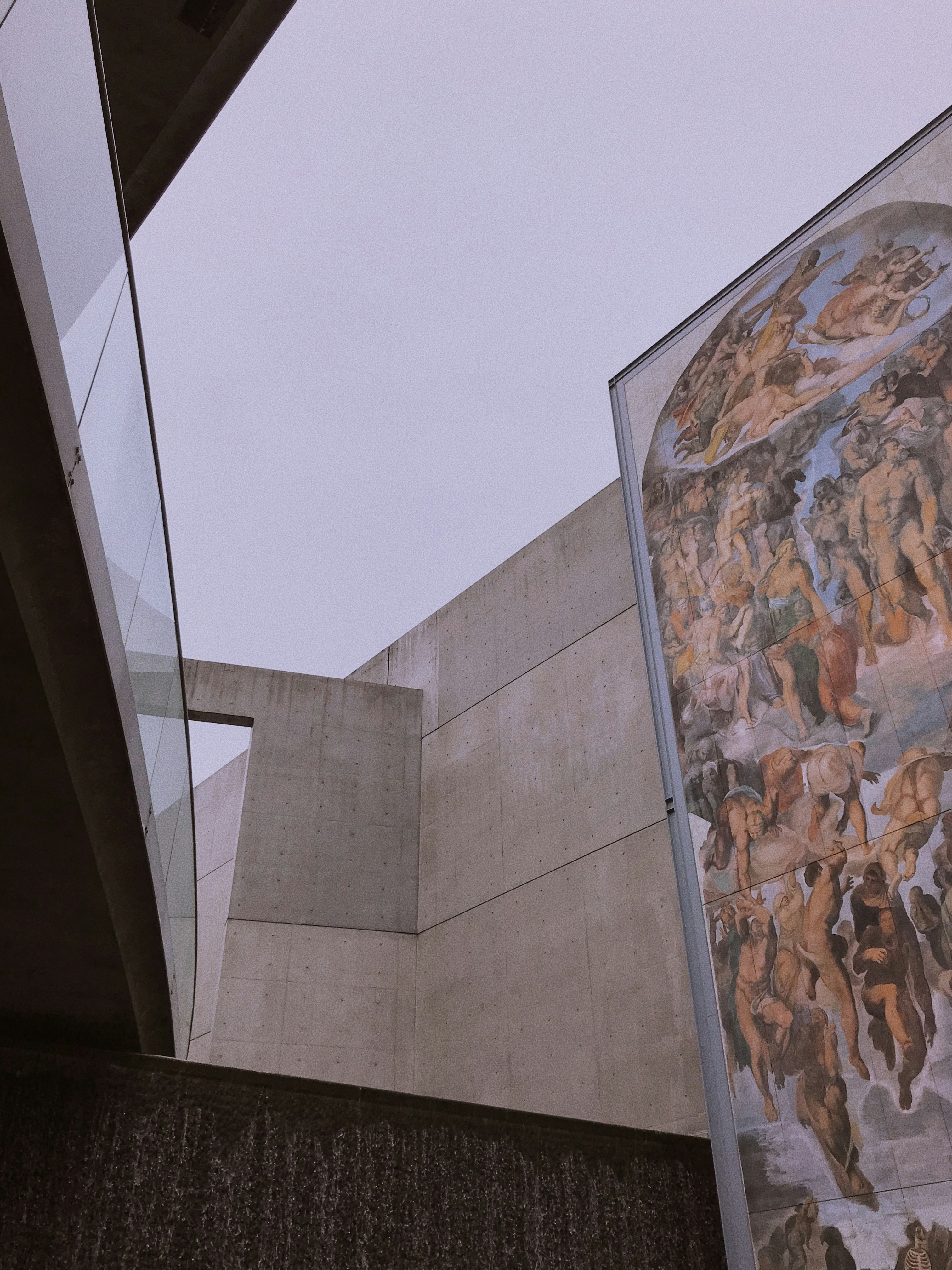 Brutalist Angles Framing a Renaissance-Style Mural