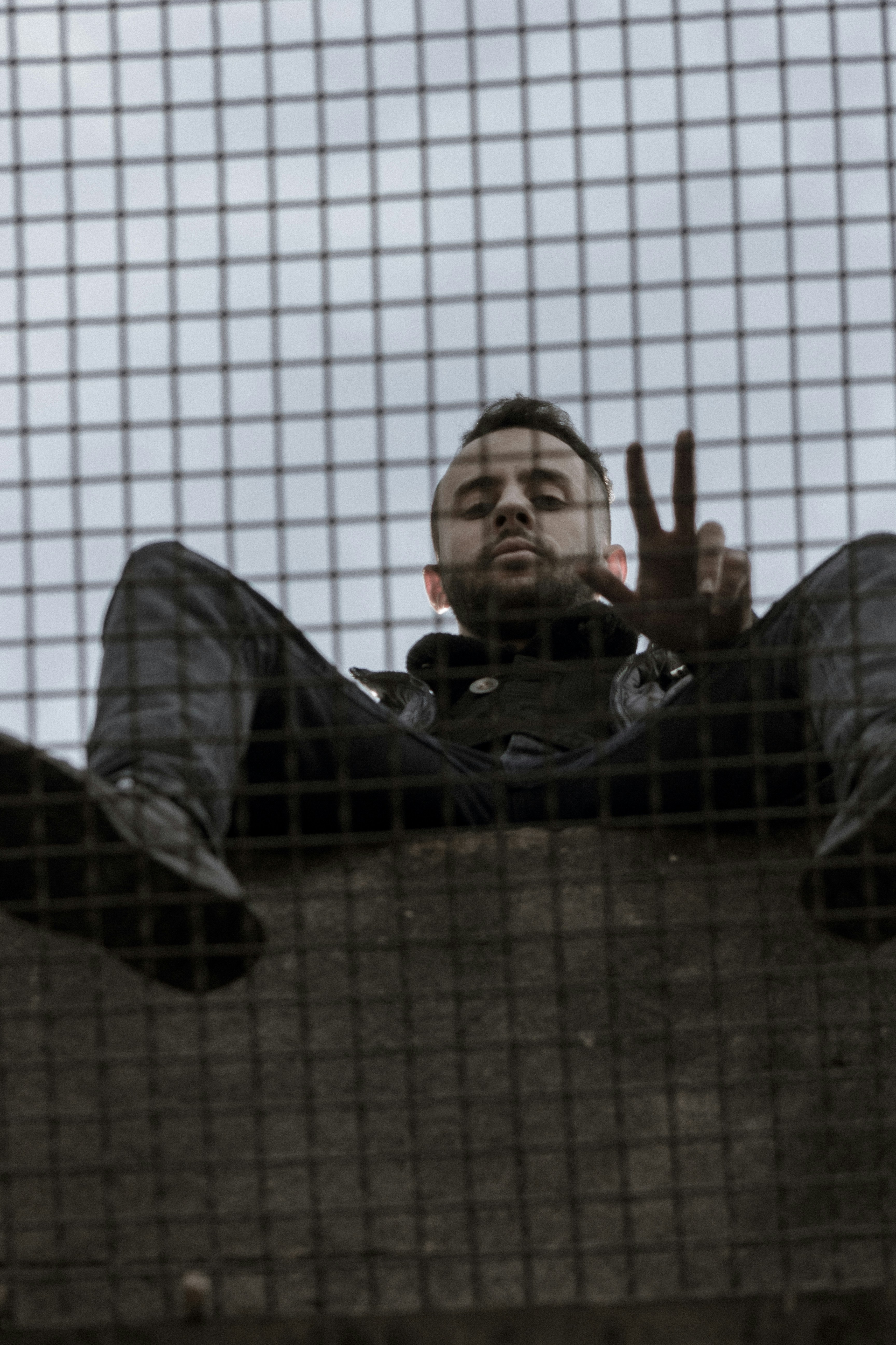 man sitting on a window during daytime