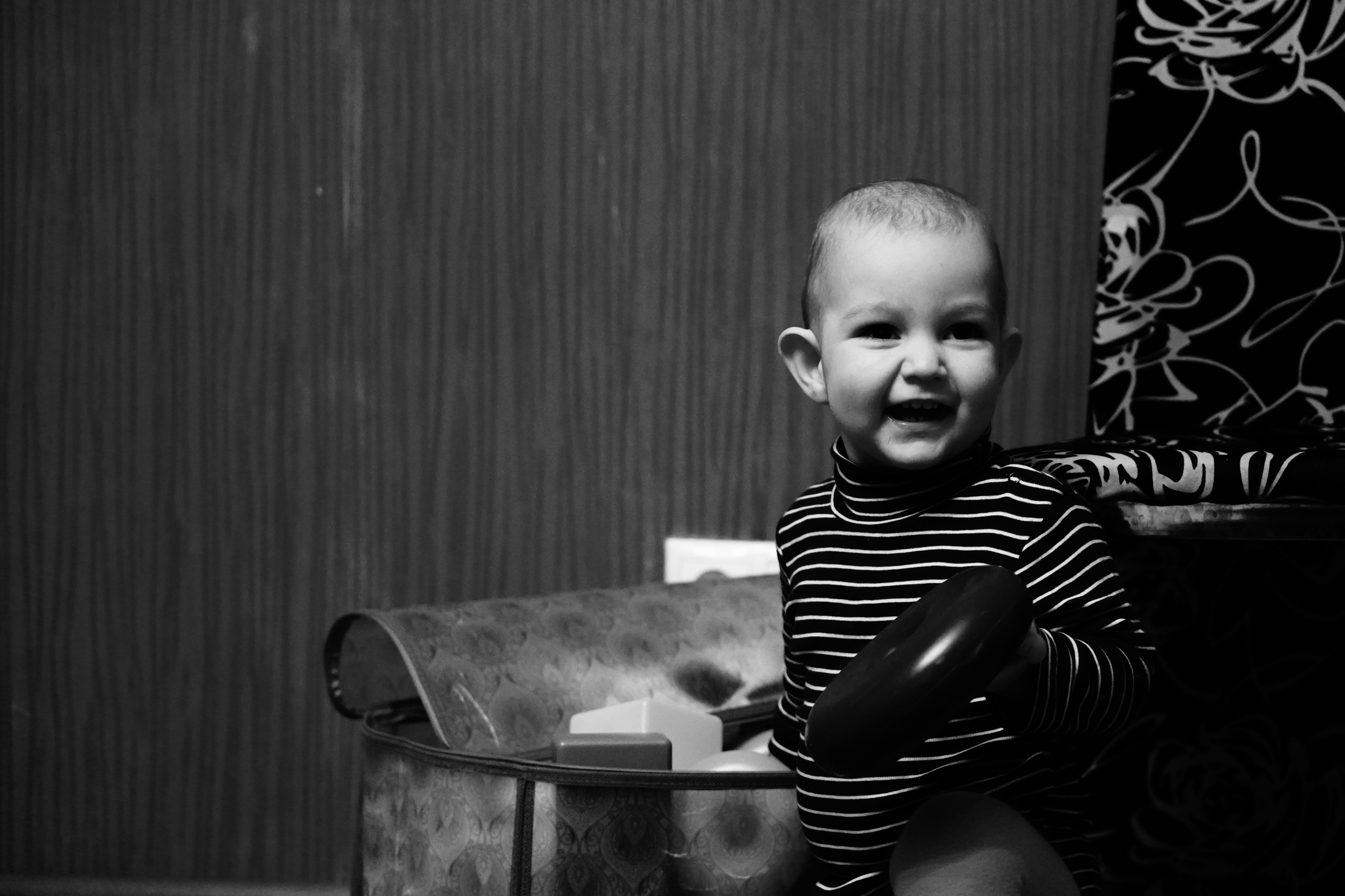 Smiling Toddler by the Cushioned Table