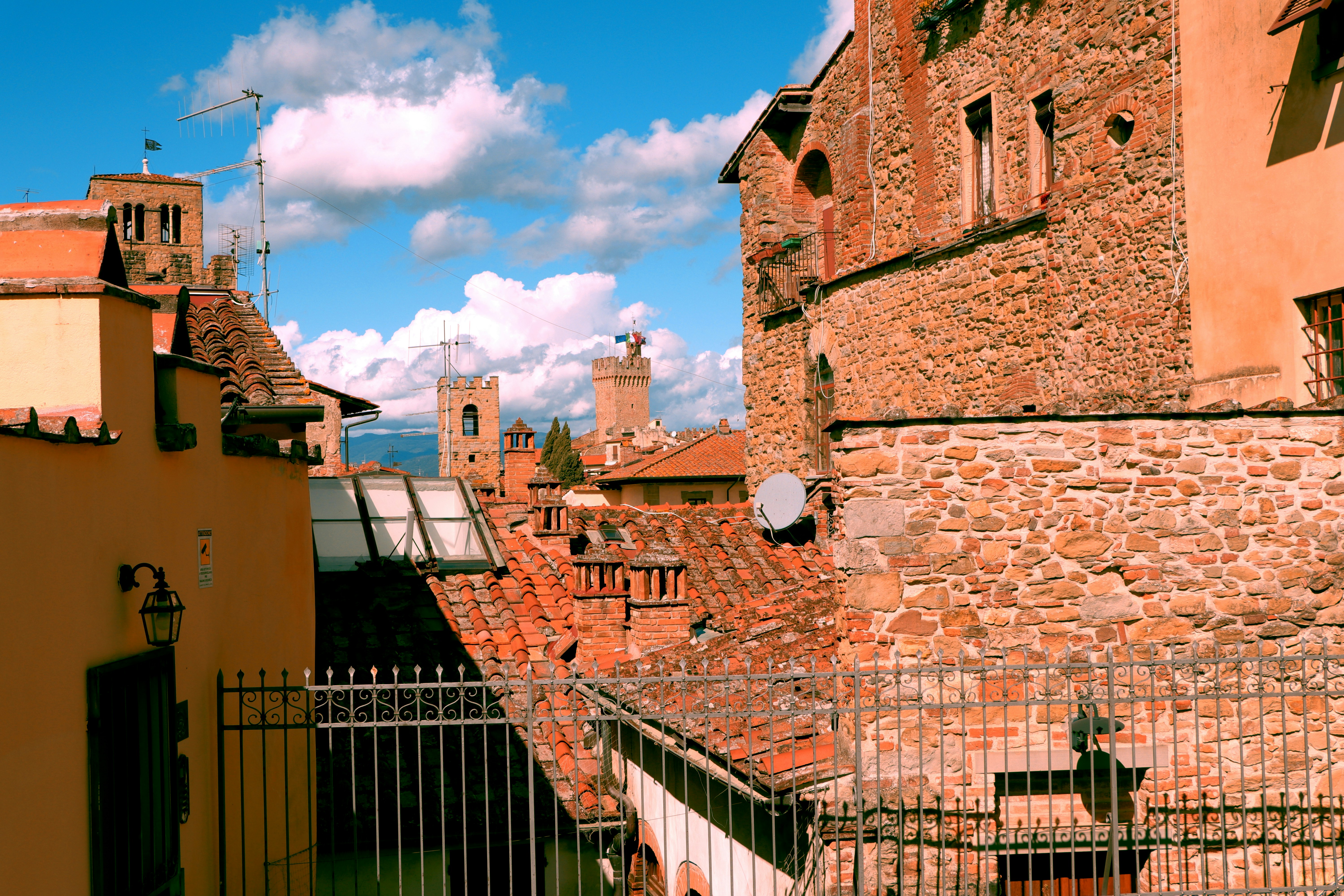 Arezzo - Piazzetta S. Niccolò | brown brick building under blue sky during daytime