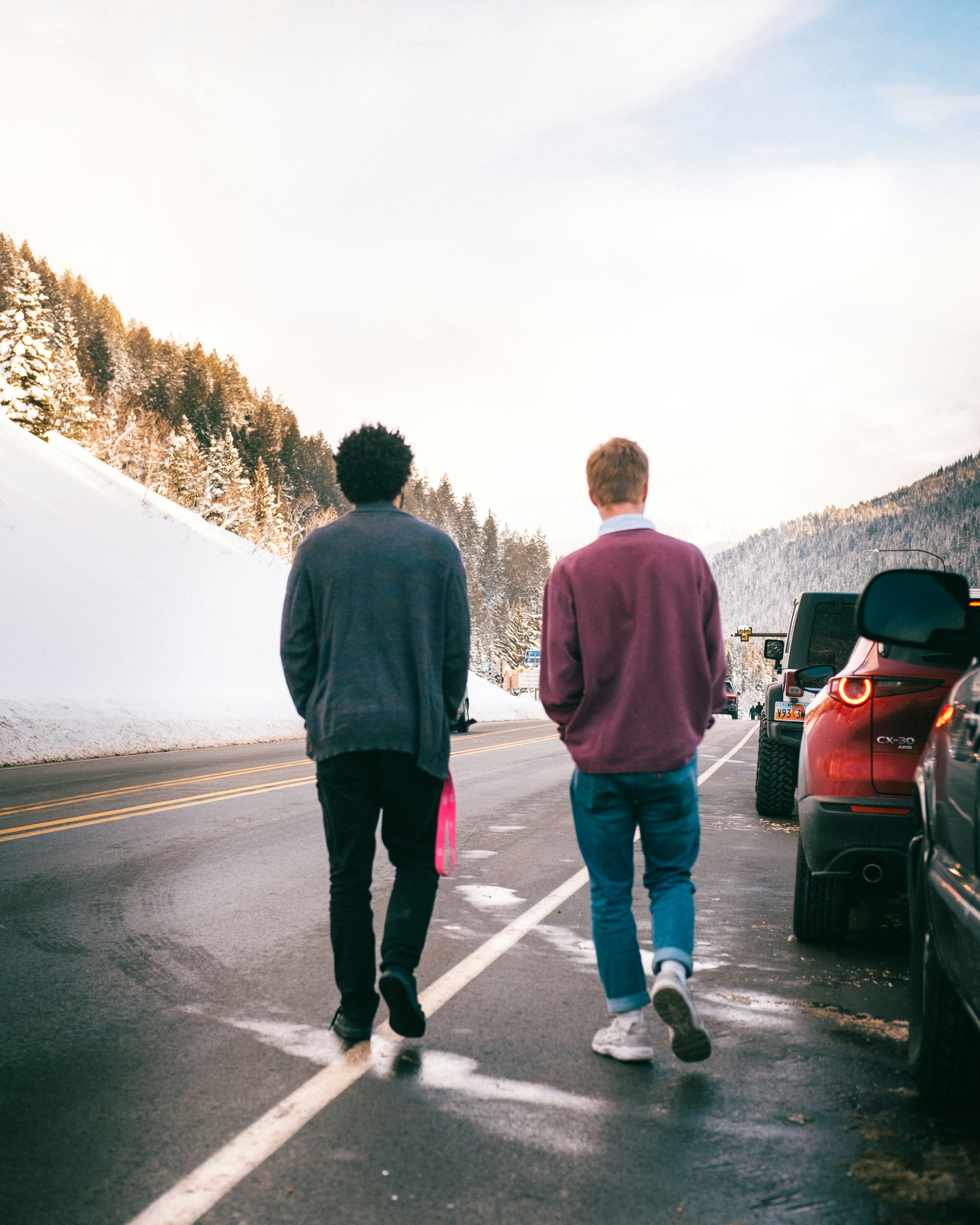 Two Friends on a Snowbound Highway: A Winter Walk Toward the Pines
