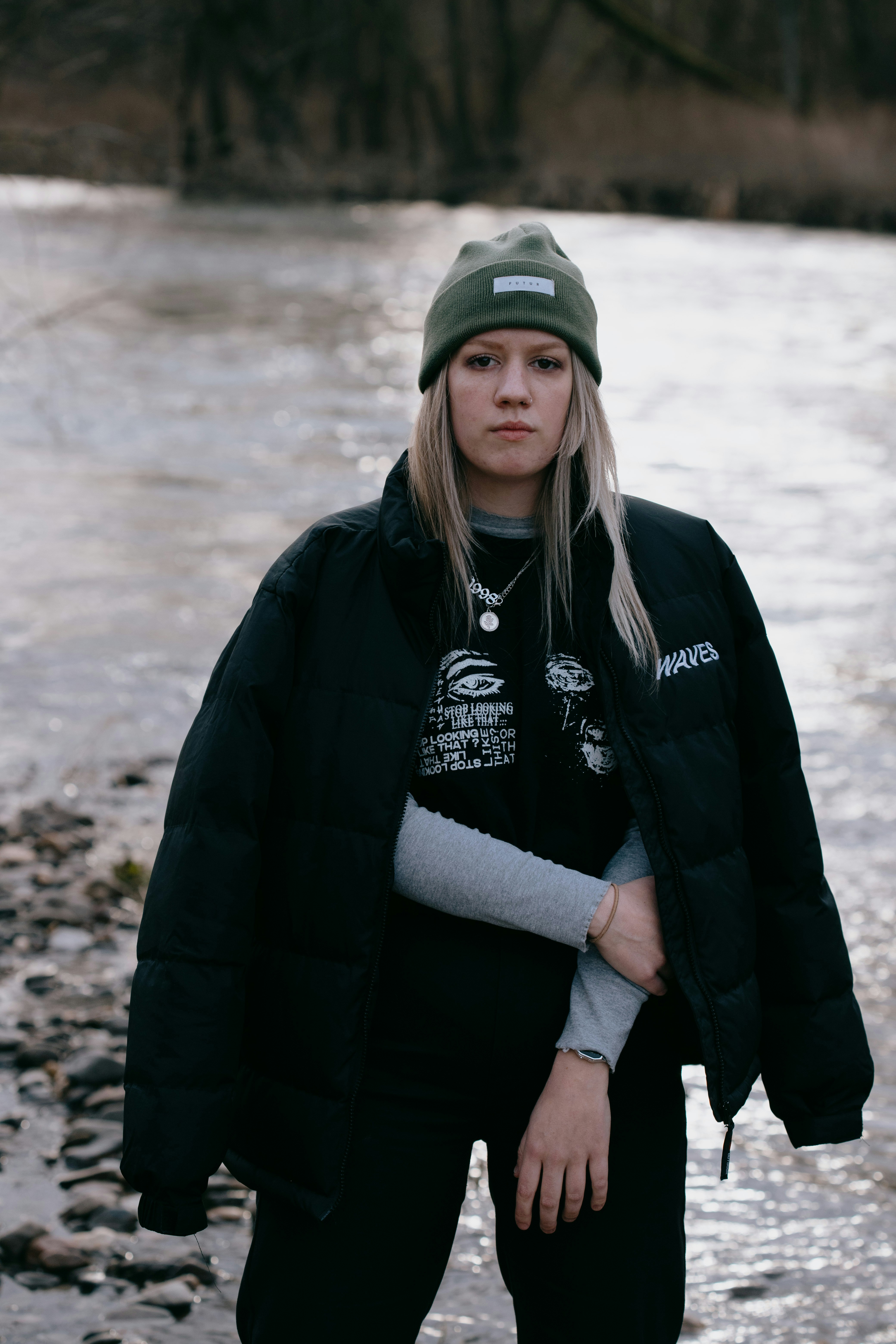 Winter River Portrait: A Quiet Gaze by the Water in an Olive Beanie