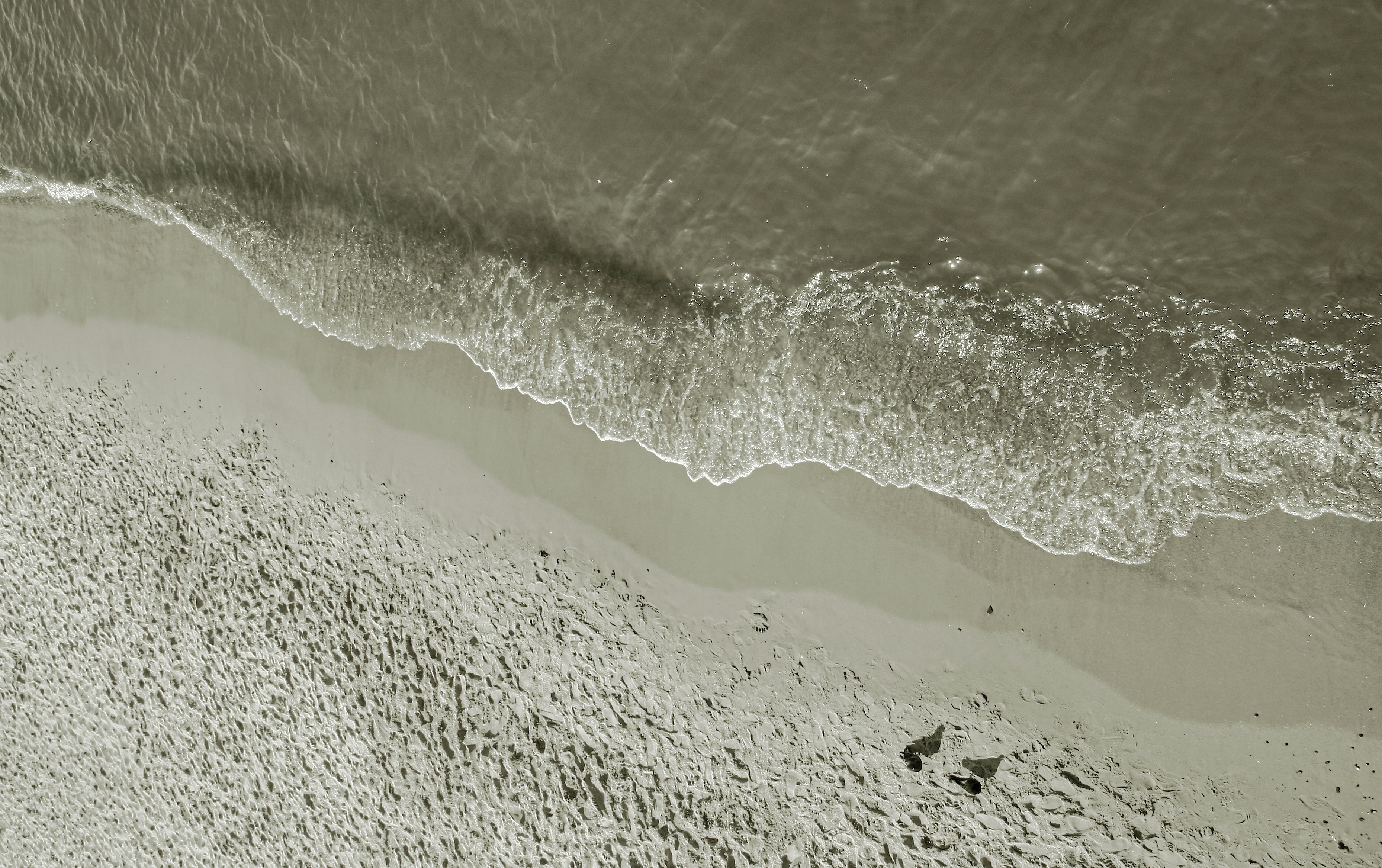 Above the Curl: An Aerial Sepia Shoreline Study