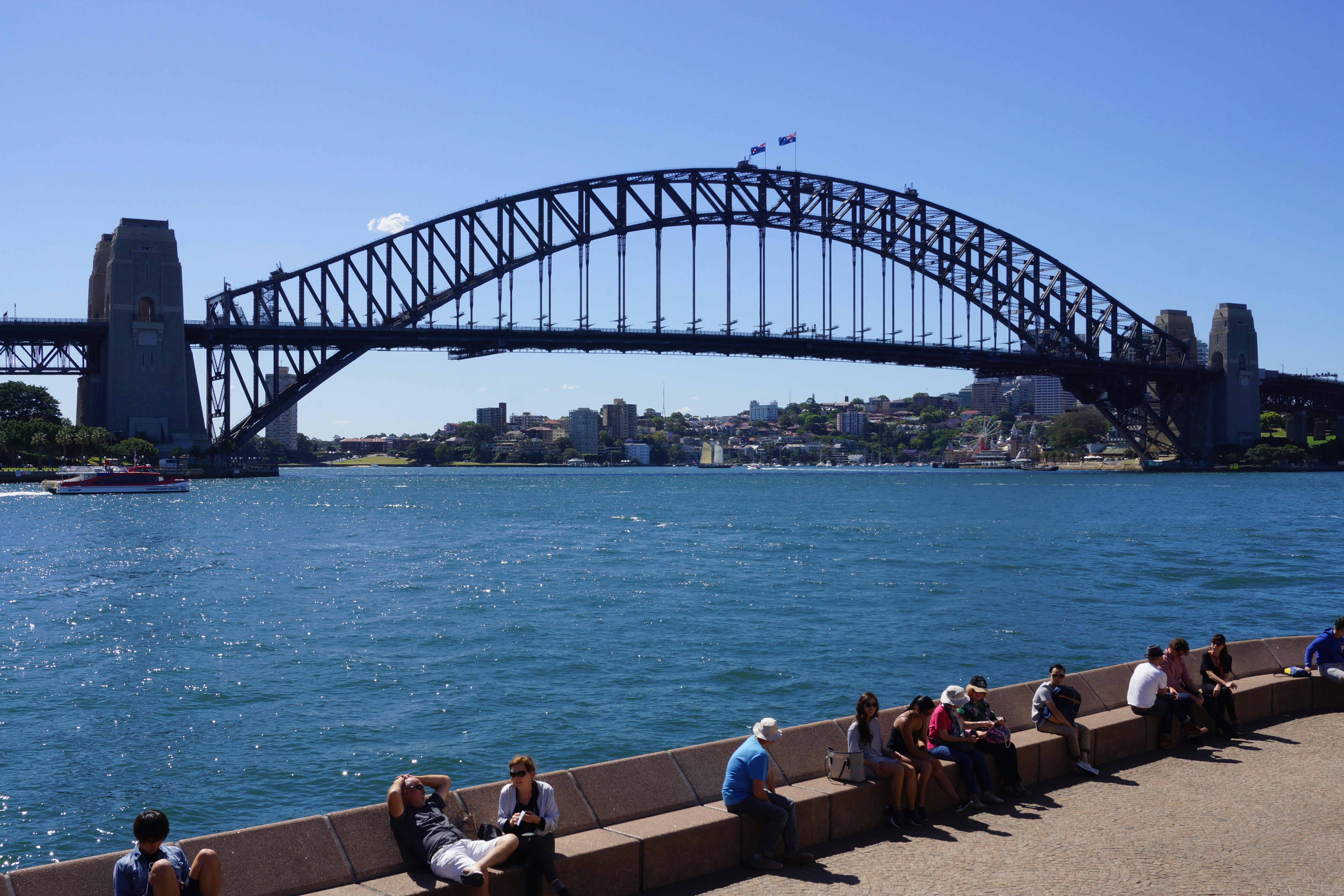 Azure Arch Over the Harbour: Sydney's Harbour Bridge Framed by a Sunlit Esplanade