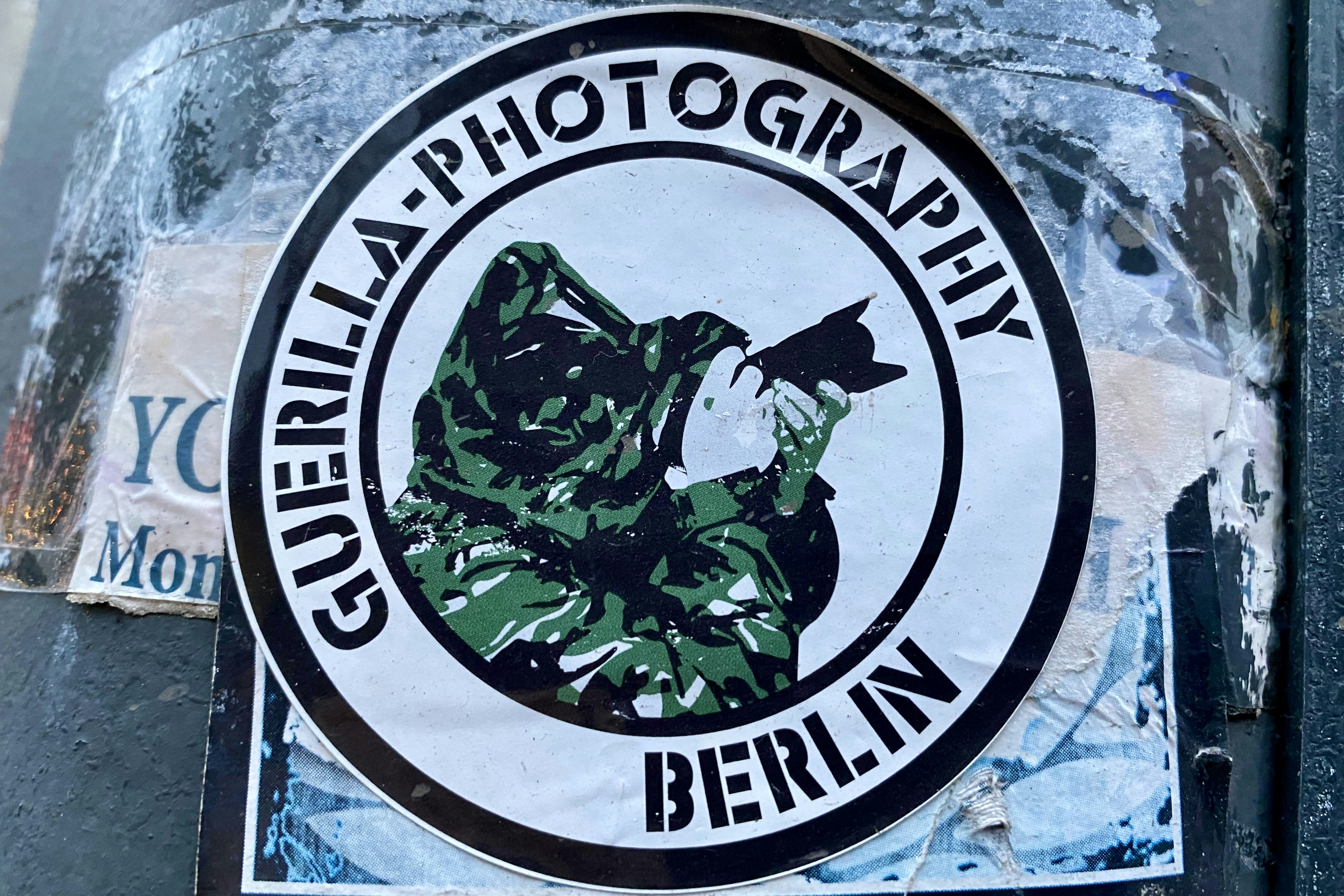 Emblem on a Weathered Wall: Guerrilla Photography Berlin Sticker
