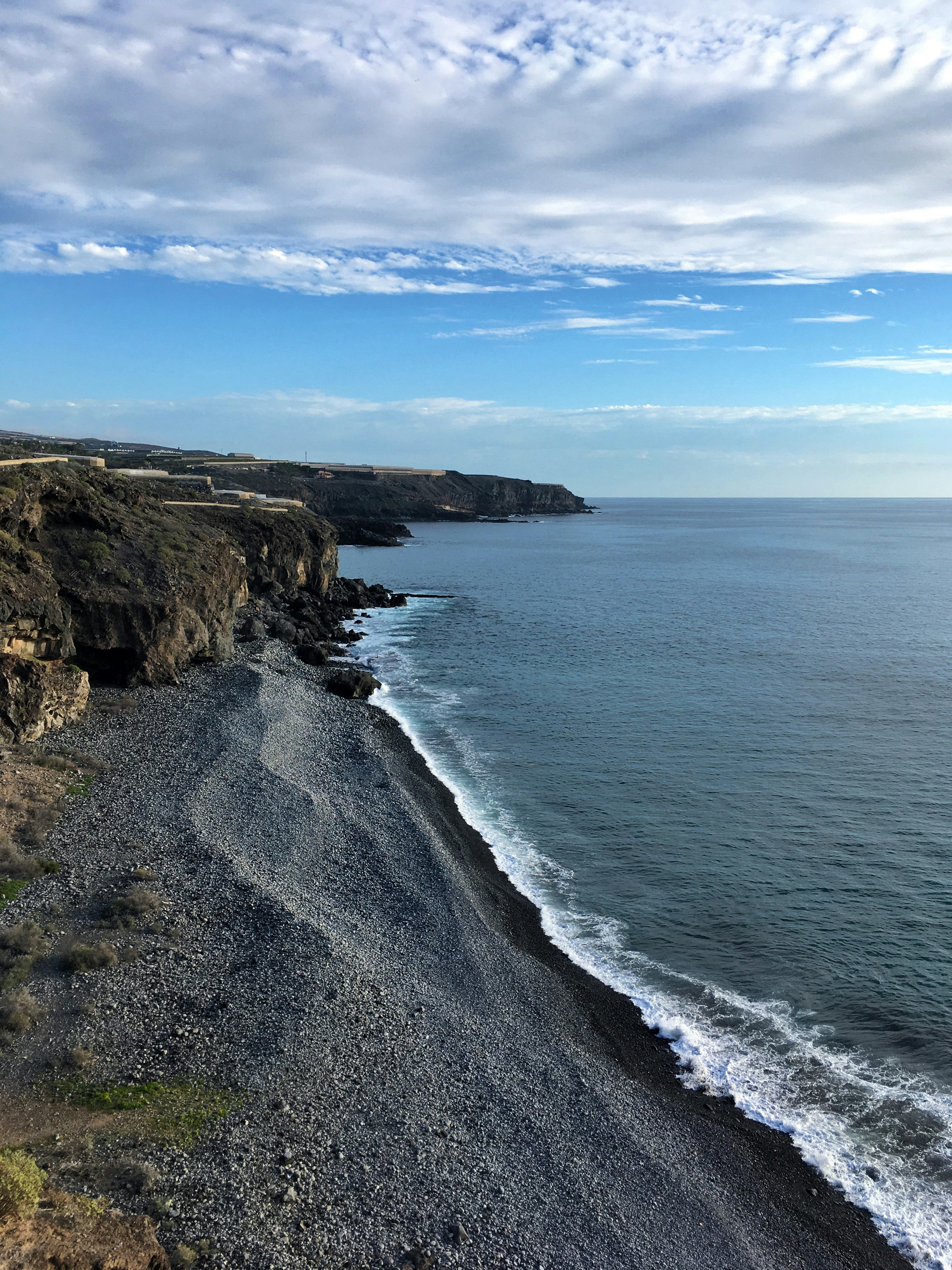 Coastal Edge: Pebbles, Cliffs, and the Quiet Sea