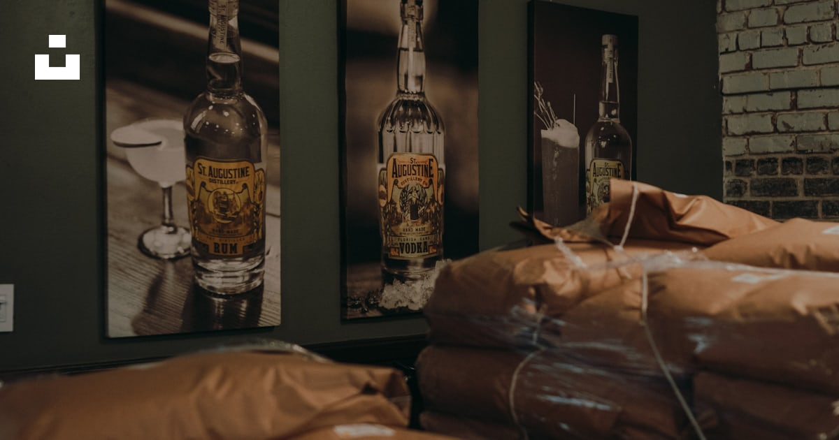 Clear Glass Bottle Beside Brown Paper Bag Photo Free Whiskey Image On