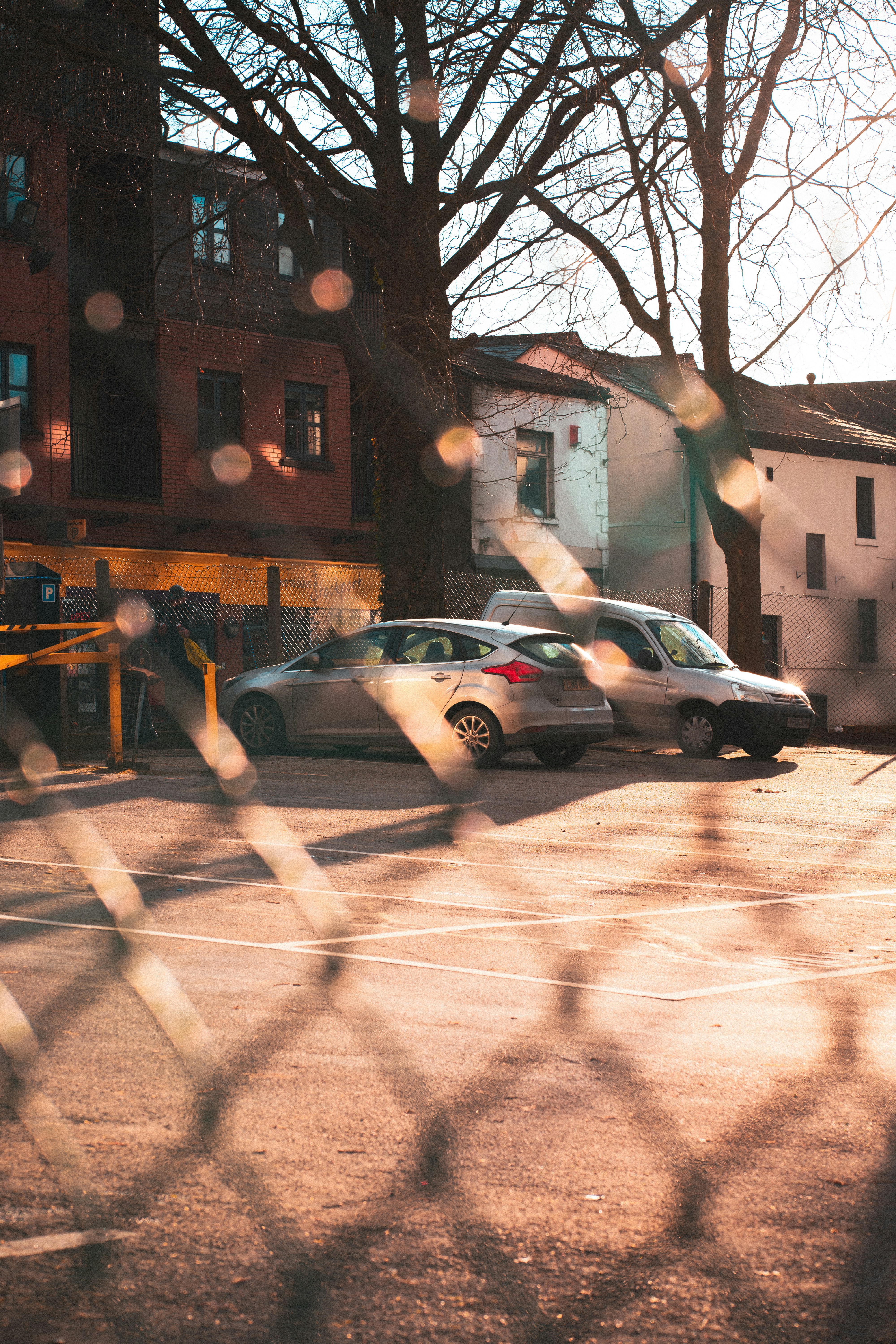 Hidden Parking Lot in Sunlit Chains Link
