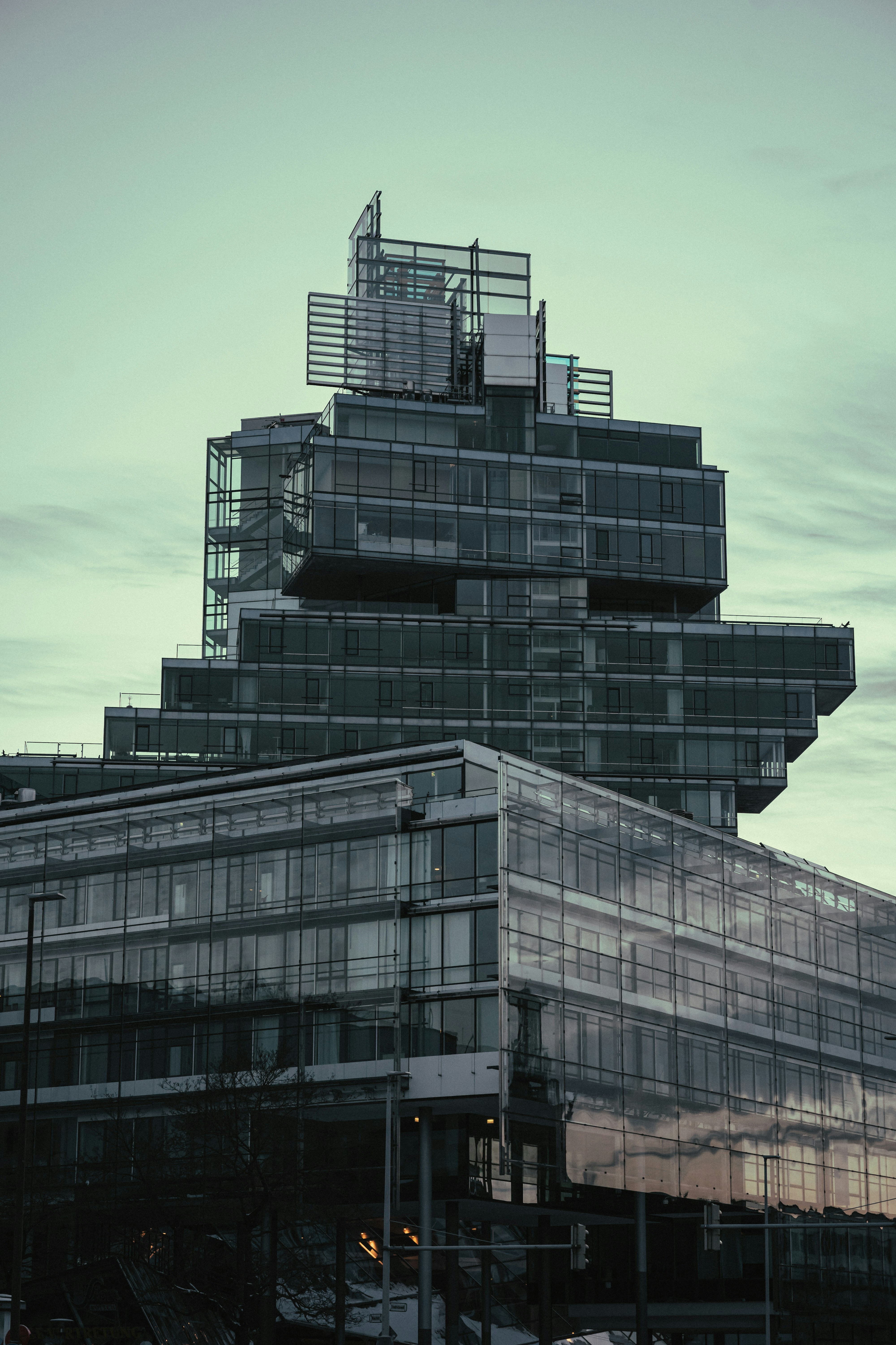 Terraced Glass Monolith Rises: A Sculpted Sky-ward Building