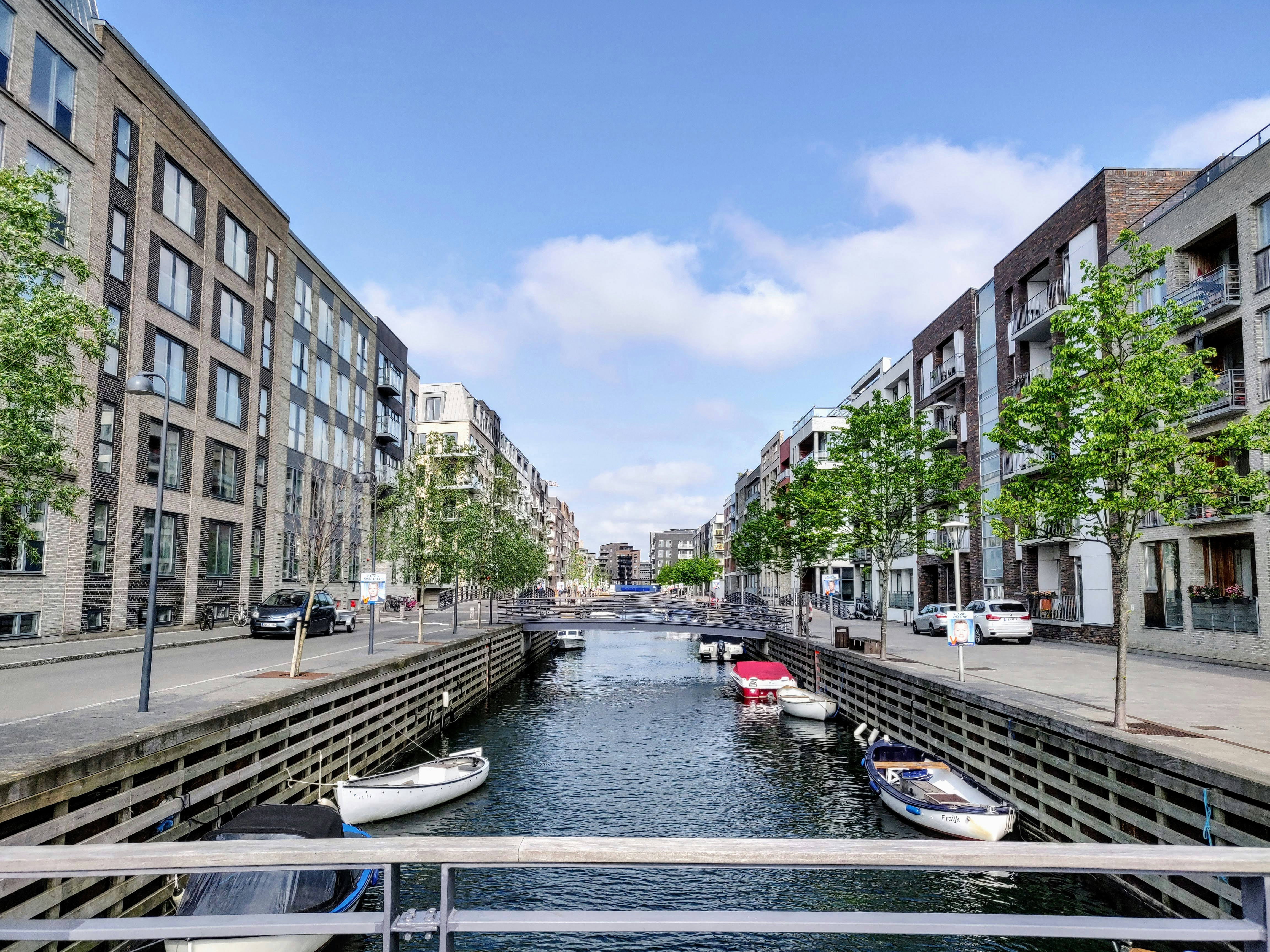 White boat on river between buildings during daytime photo – Free ...