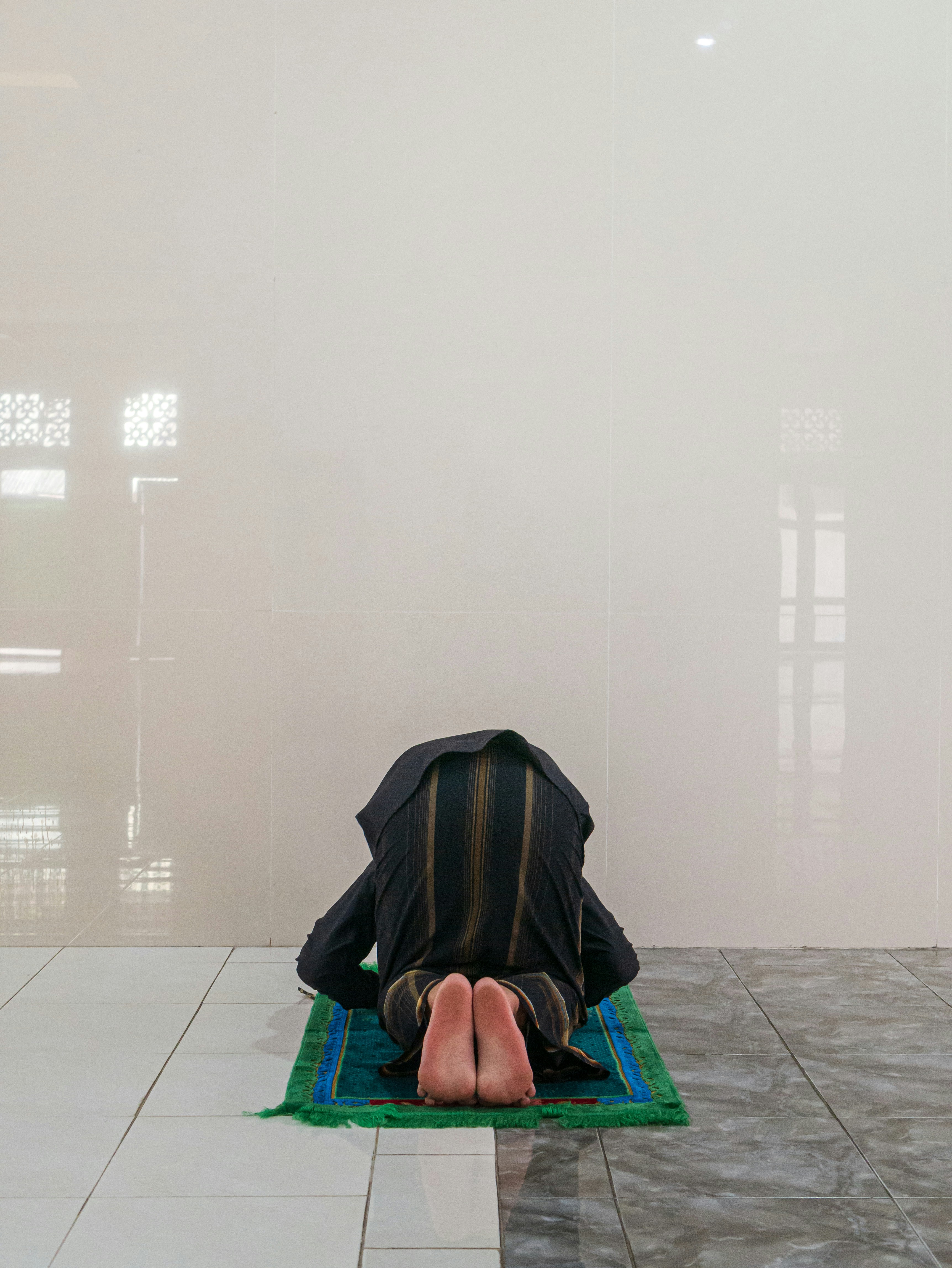 Kneeling in Quiet Prayer on a Green Rug
