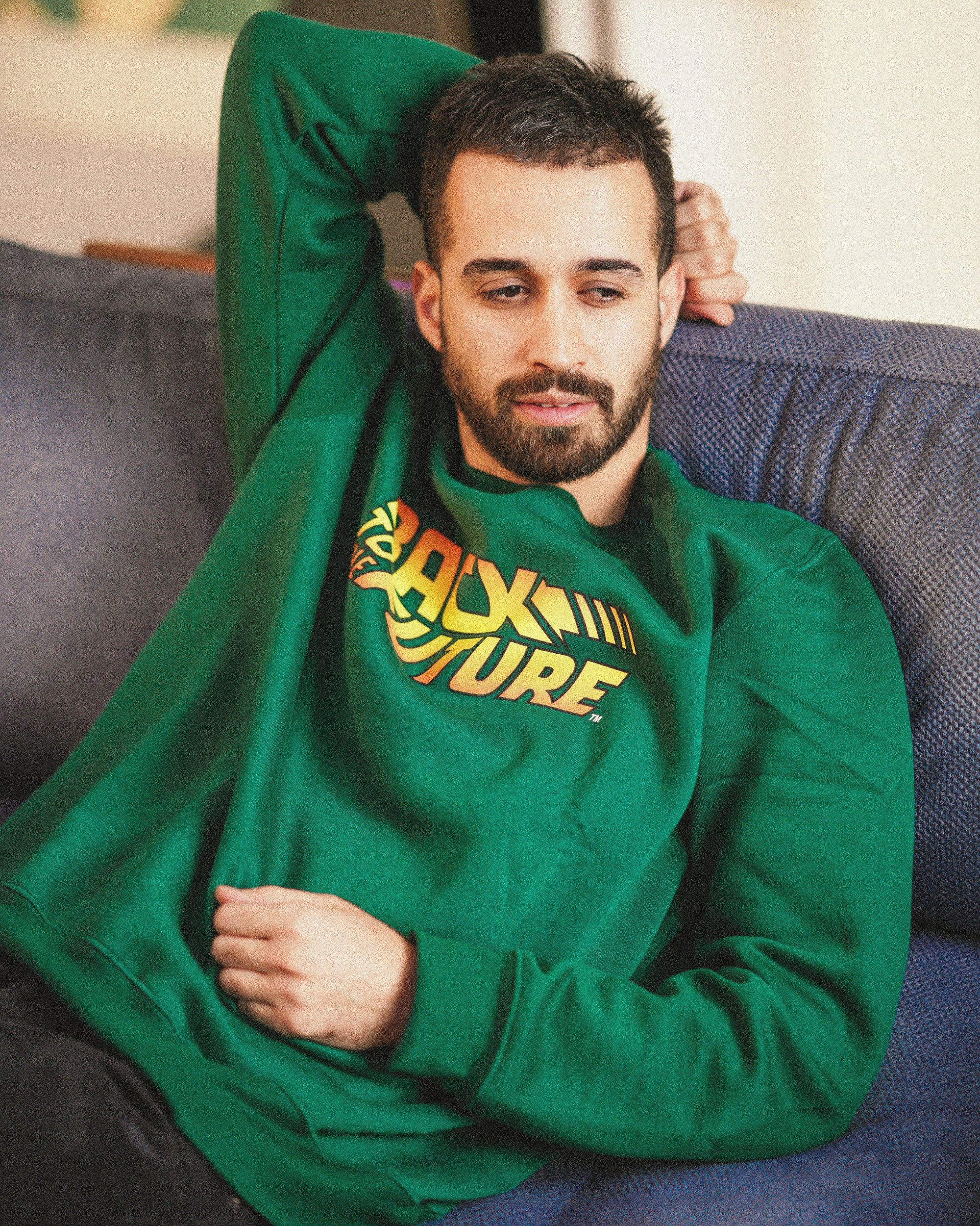 Green Sweatshirt Quietude: A Casual Portrait on a Couch