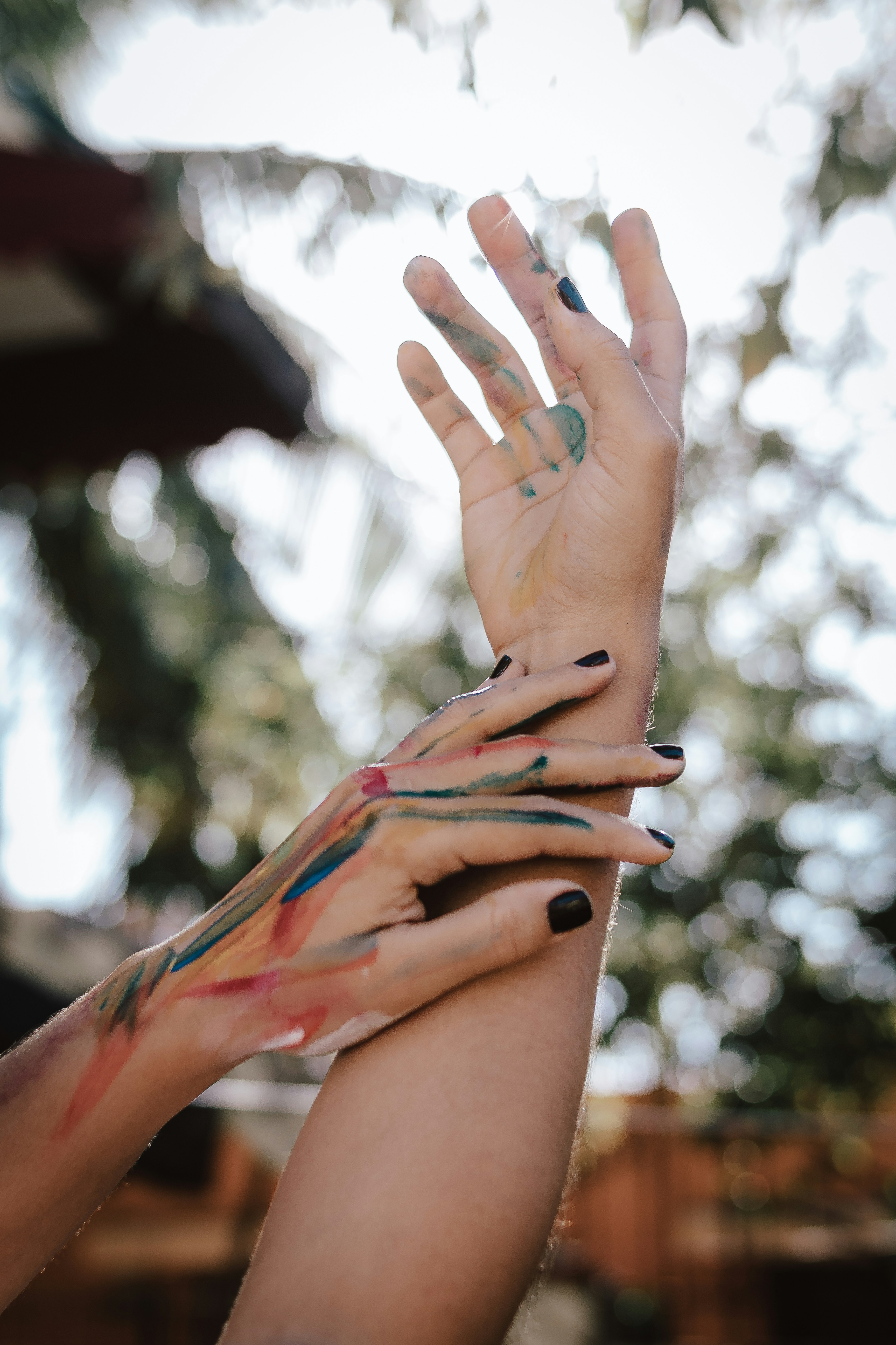 Painted Hands Lift: A Moment of Shared Color