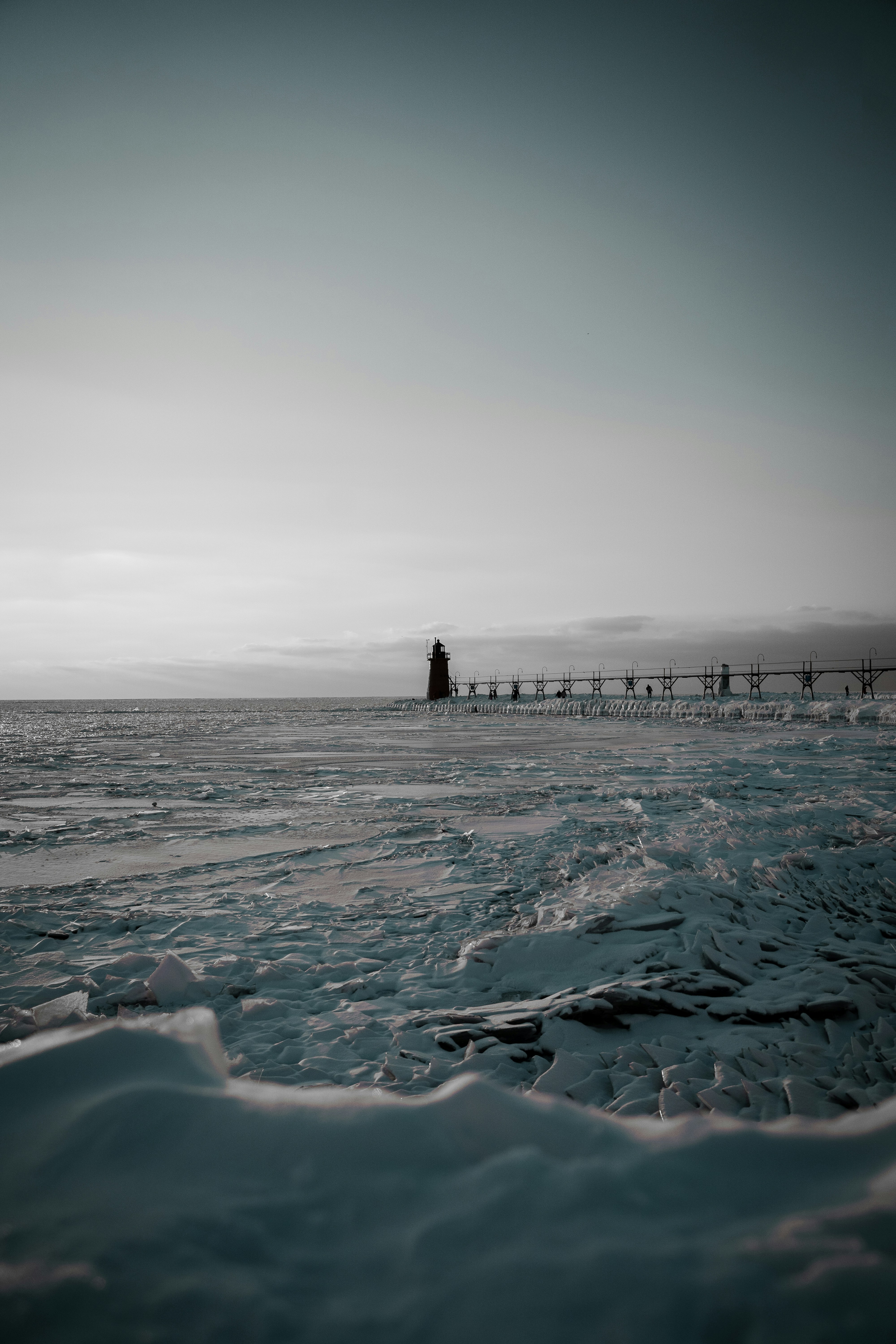 Lighthouse at the Frostbound Pier Under a Pale Arctic Sky
