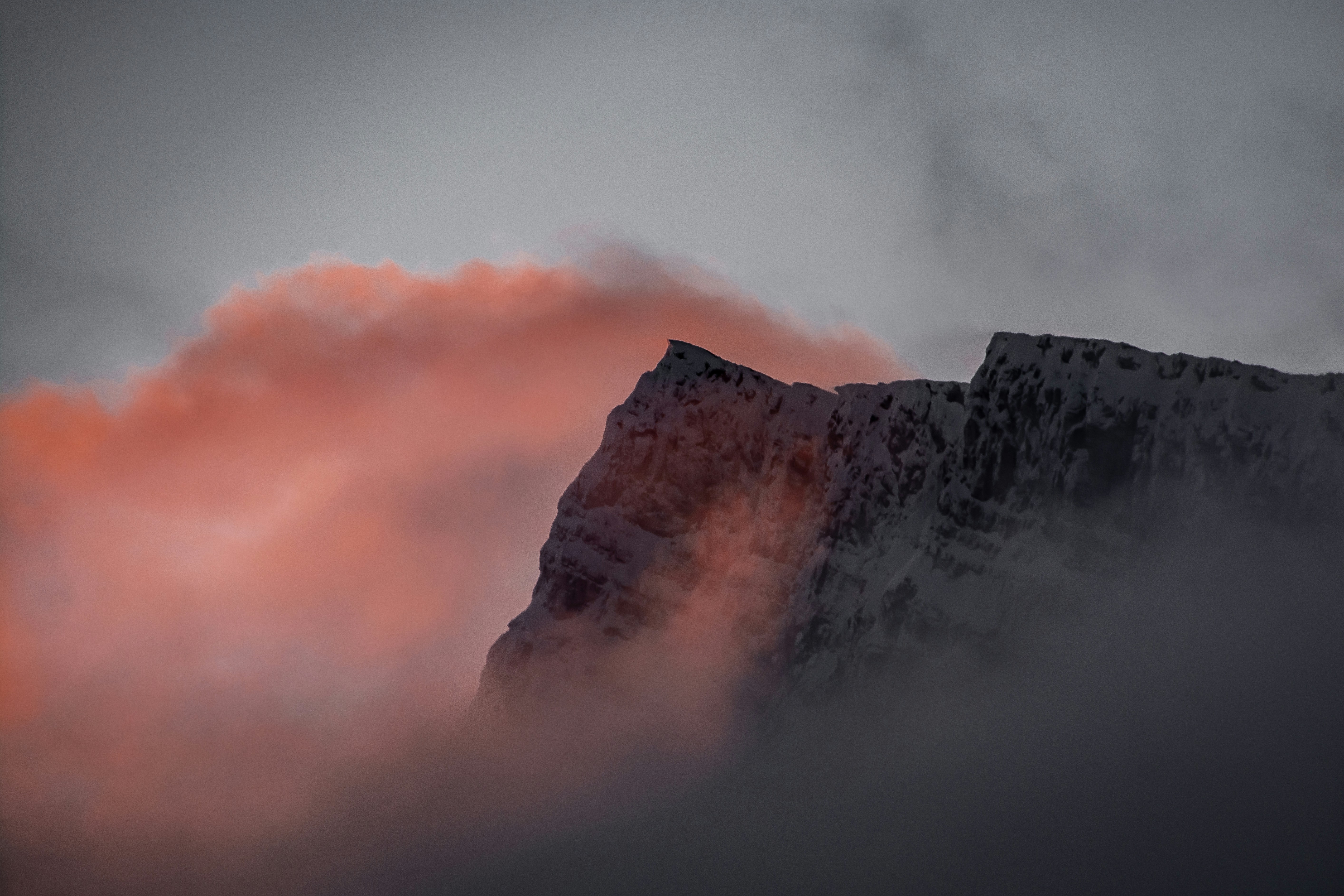 Sunlit Ridge: A Mountain PeakEmerging from the Clouds