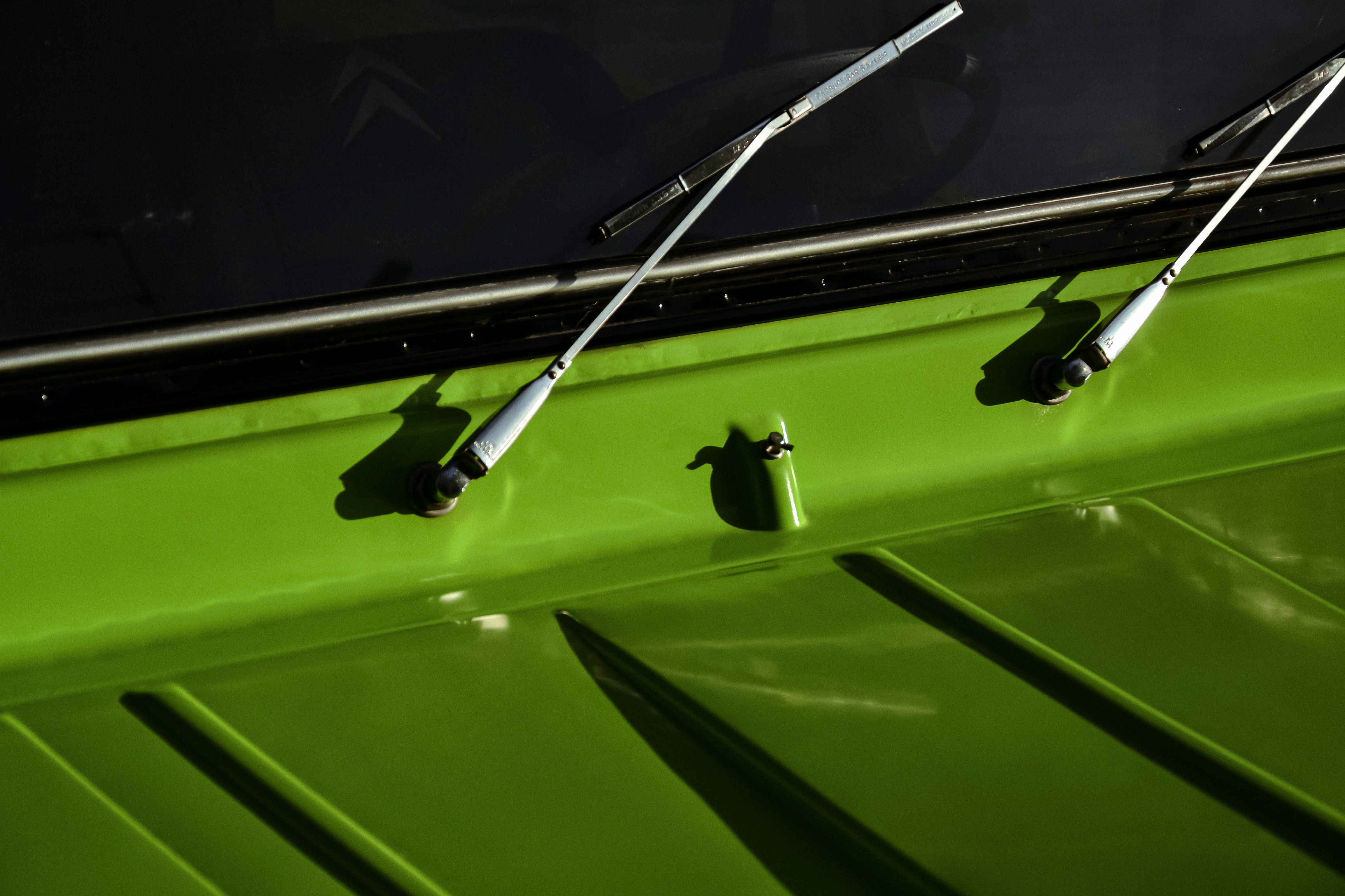 Lime Gloss and Wiper Lines: A Close-Up on a Vibrant Green Hood