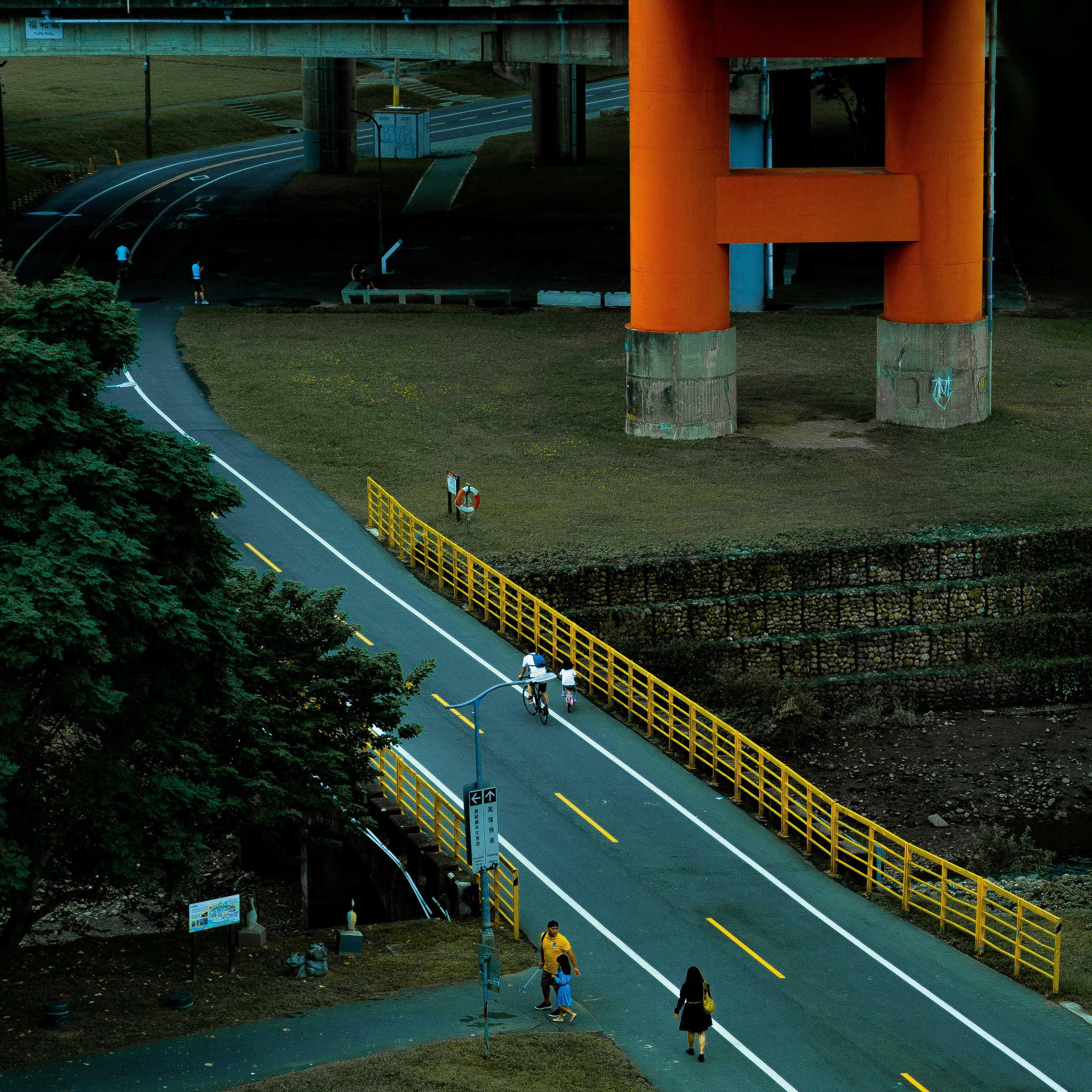 people walking on road near orange and gray building during daytime