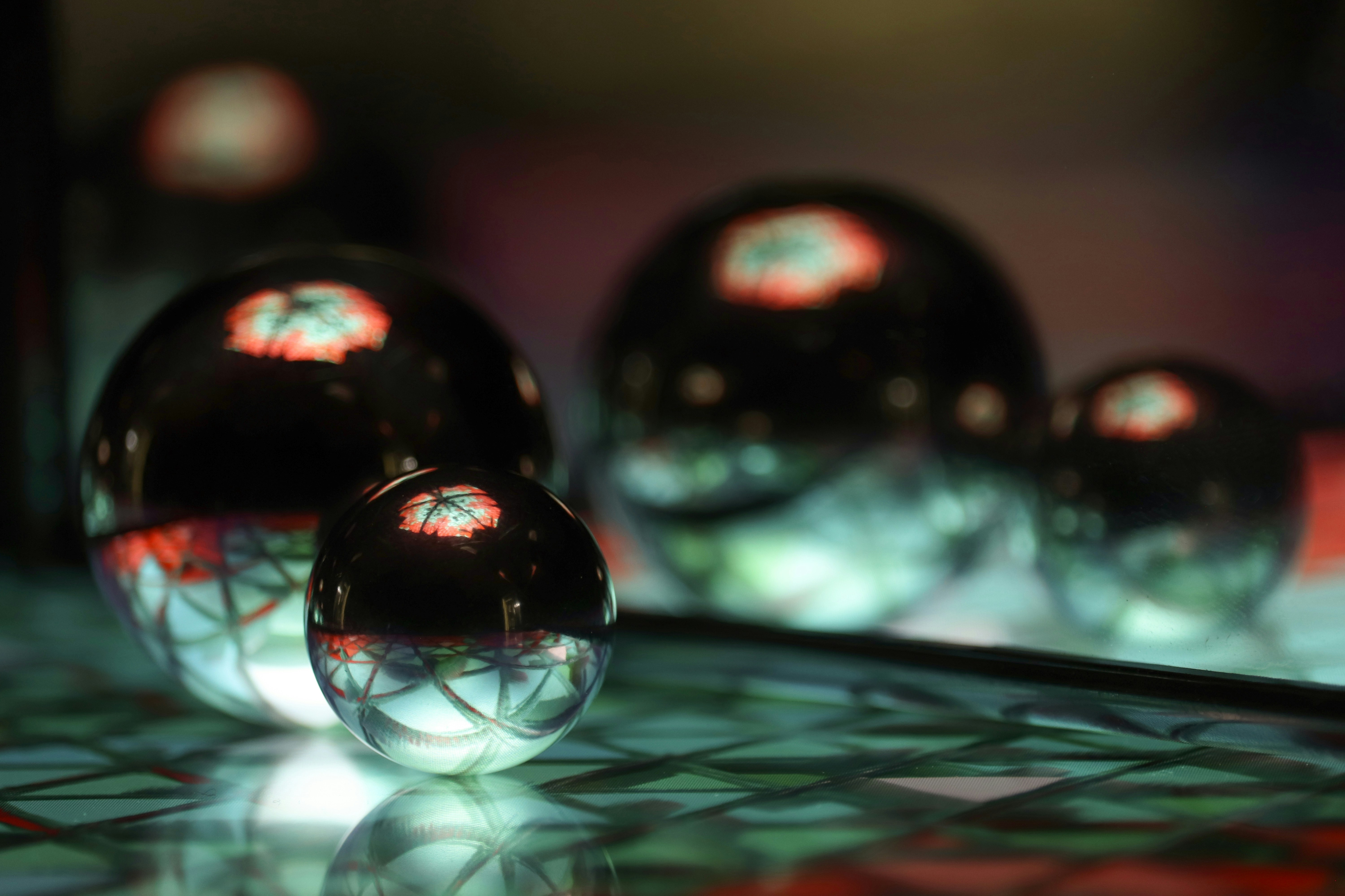 Cluster of reflective spheres with colorful patterns and light reflections.
