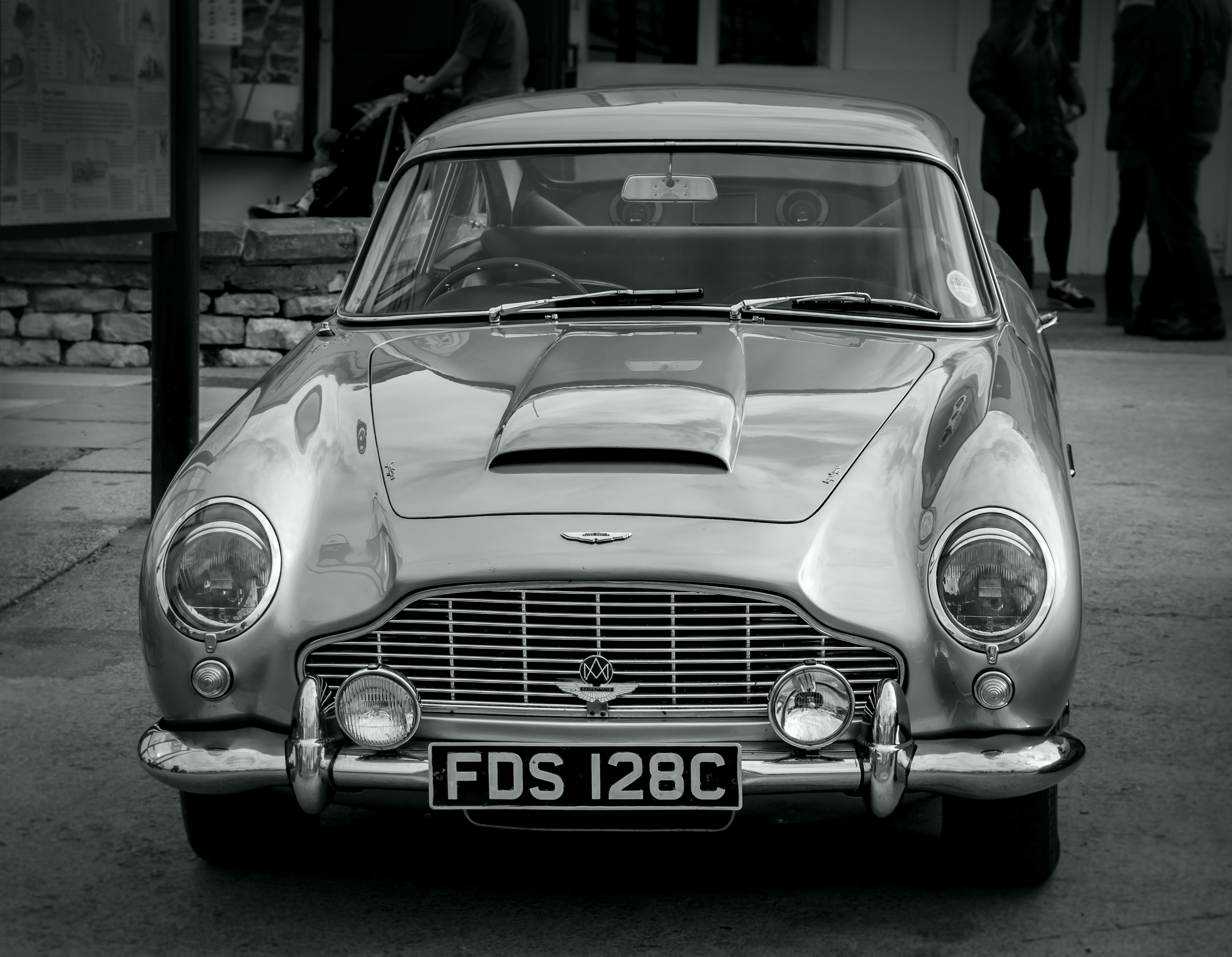 Classic Aston Martin sports car showcased in monochrome, highlighting its iconic design and vintage charm.