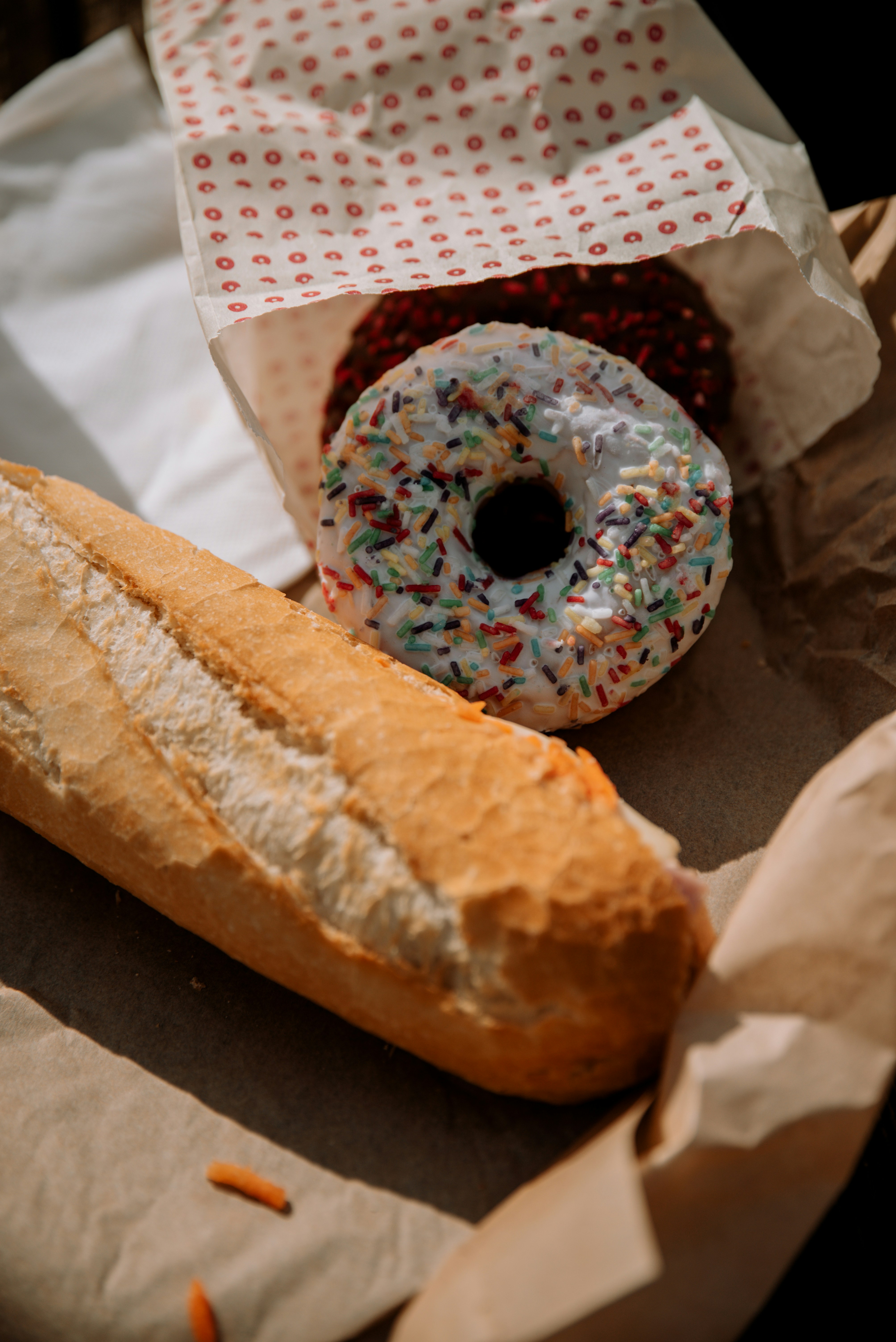 Sugared Orbit: A Glazed Donut Among Crusty Baguette Moments