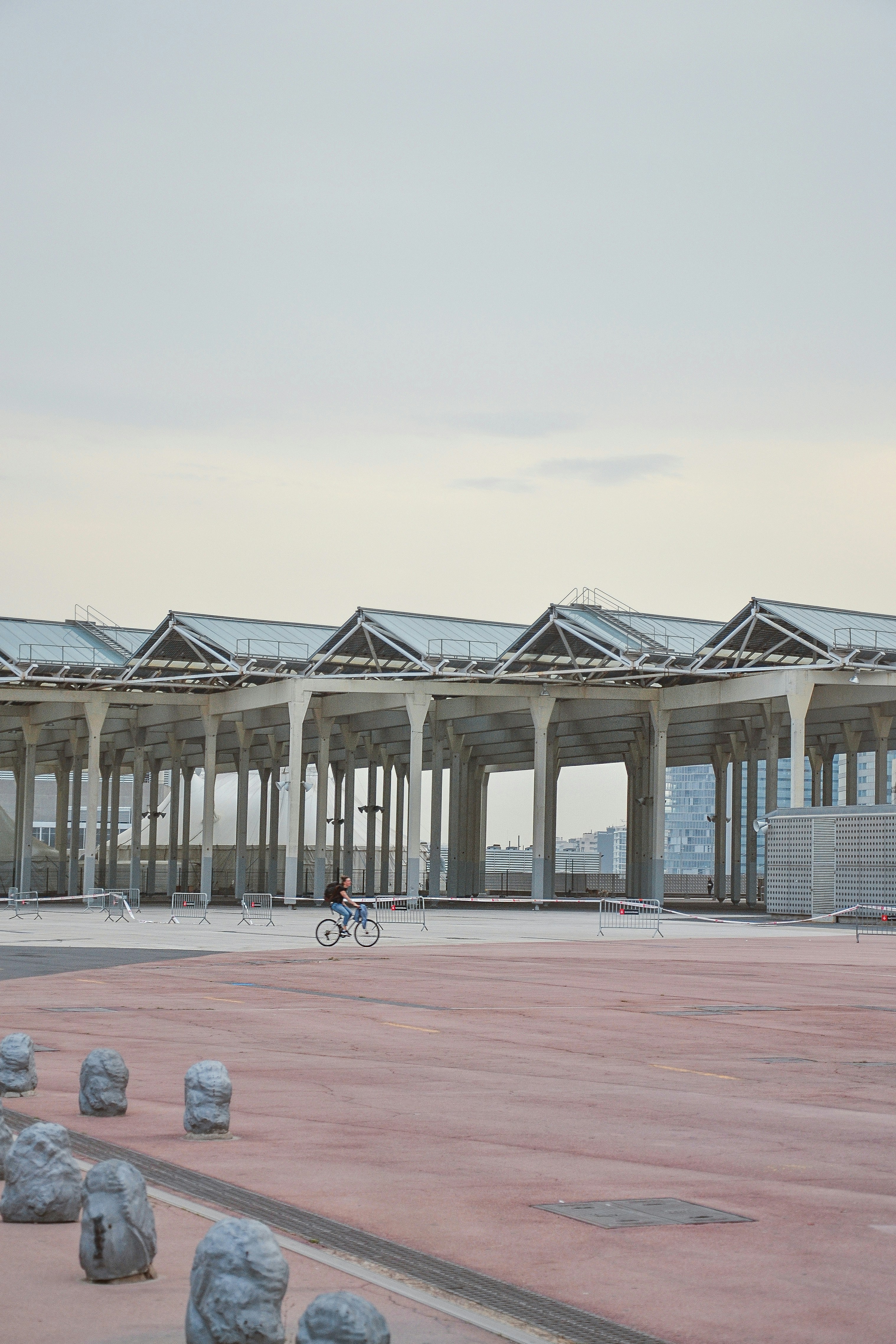 People walking on gray concrete pavement near white concrete building ...