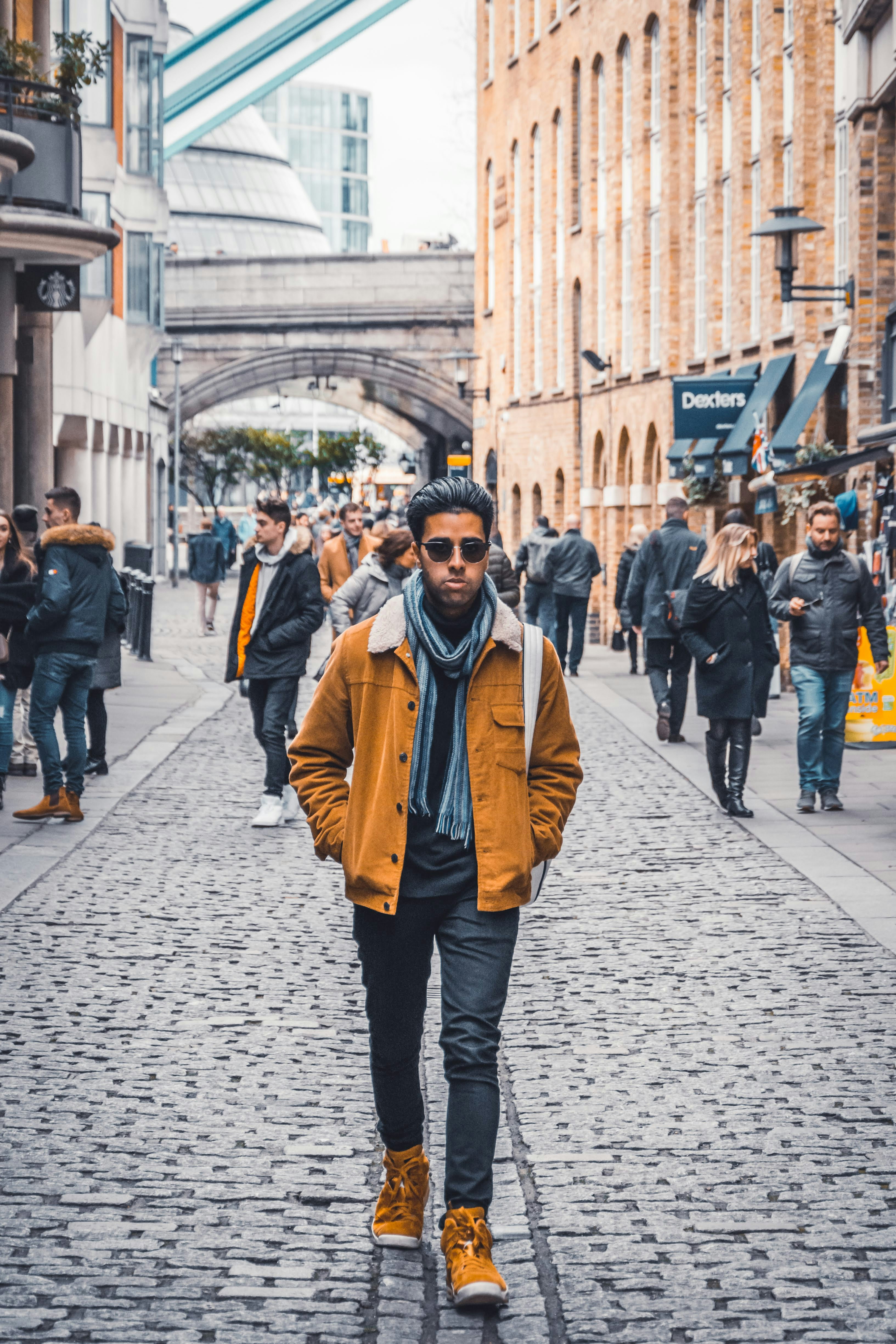 City Wanderer in Camel Hue: A Street Portrait Under Cobbled Arcades