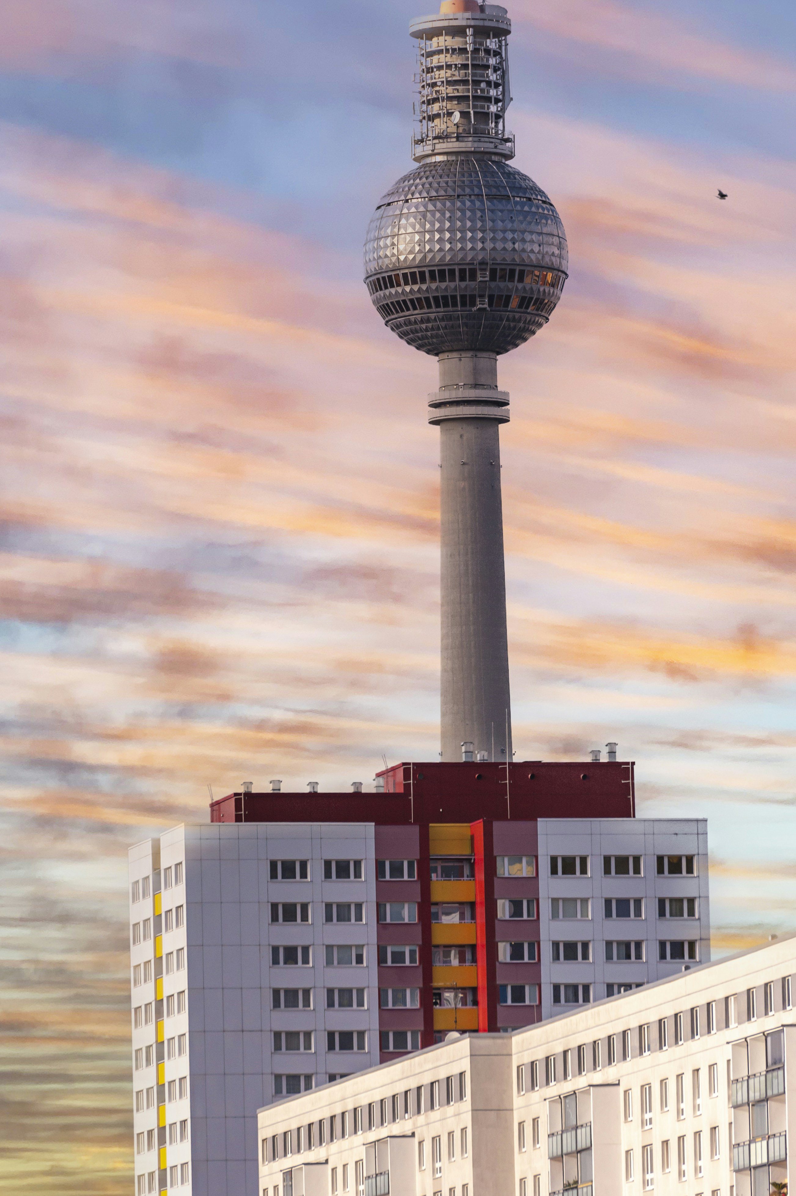 Vertical Sentinel: Berlin’s TV Tower Above Colorful Residential Molds