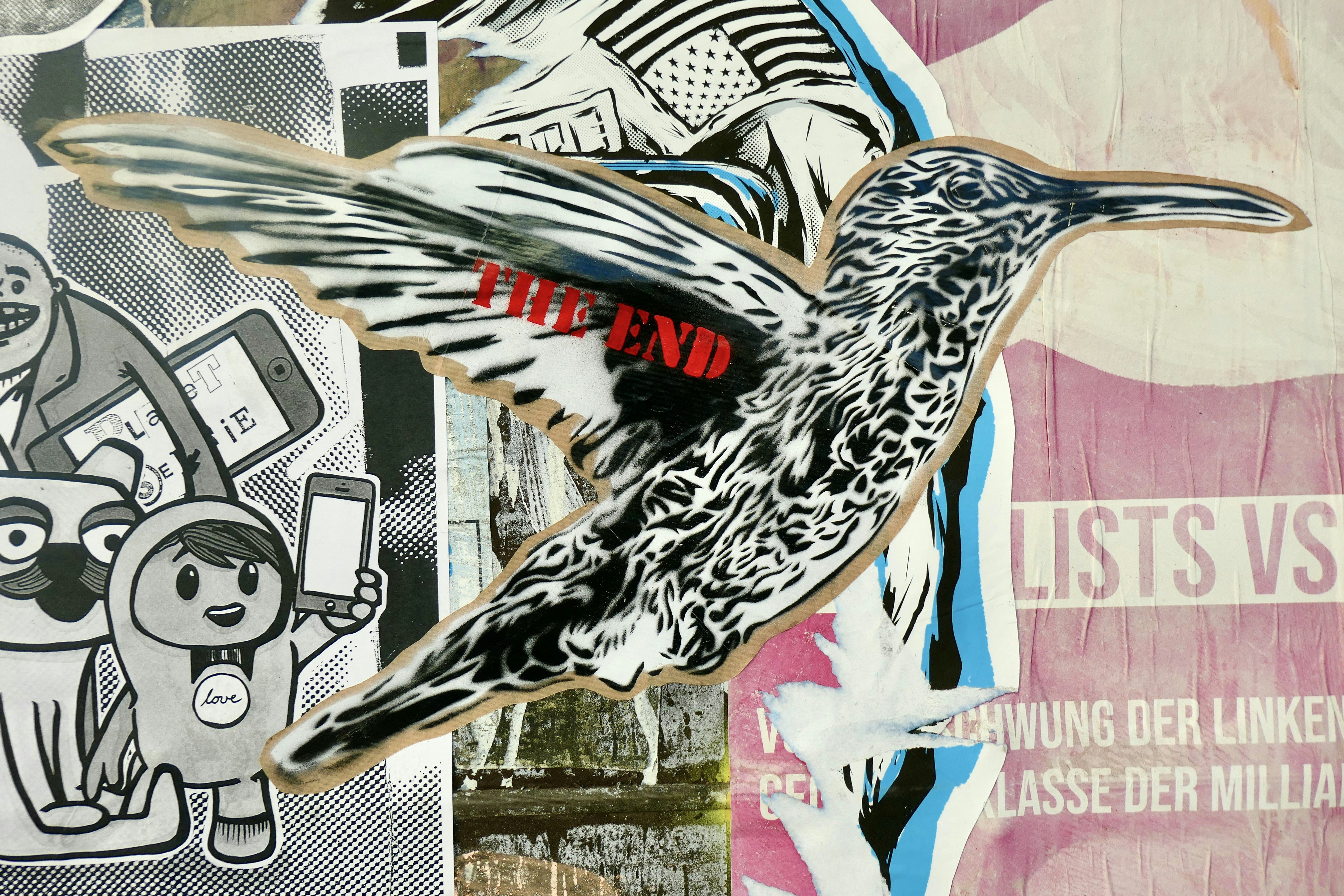 The End in Flight: A Winged Sticker Across a Wall of Urban Graffiti