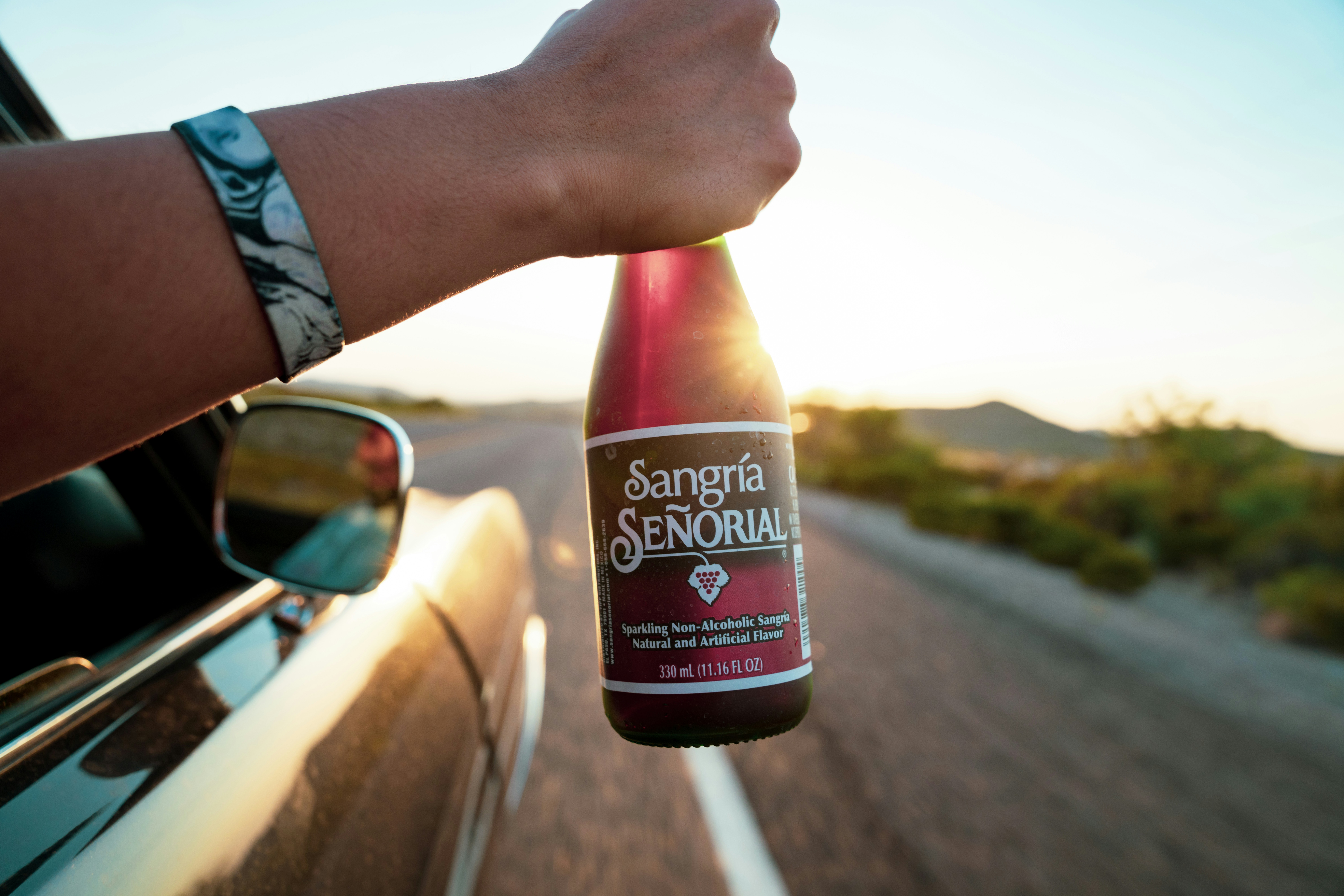 Bottle Halo: Sunset Shot of Sungria Señorial in a Desert Road Scene