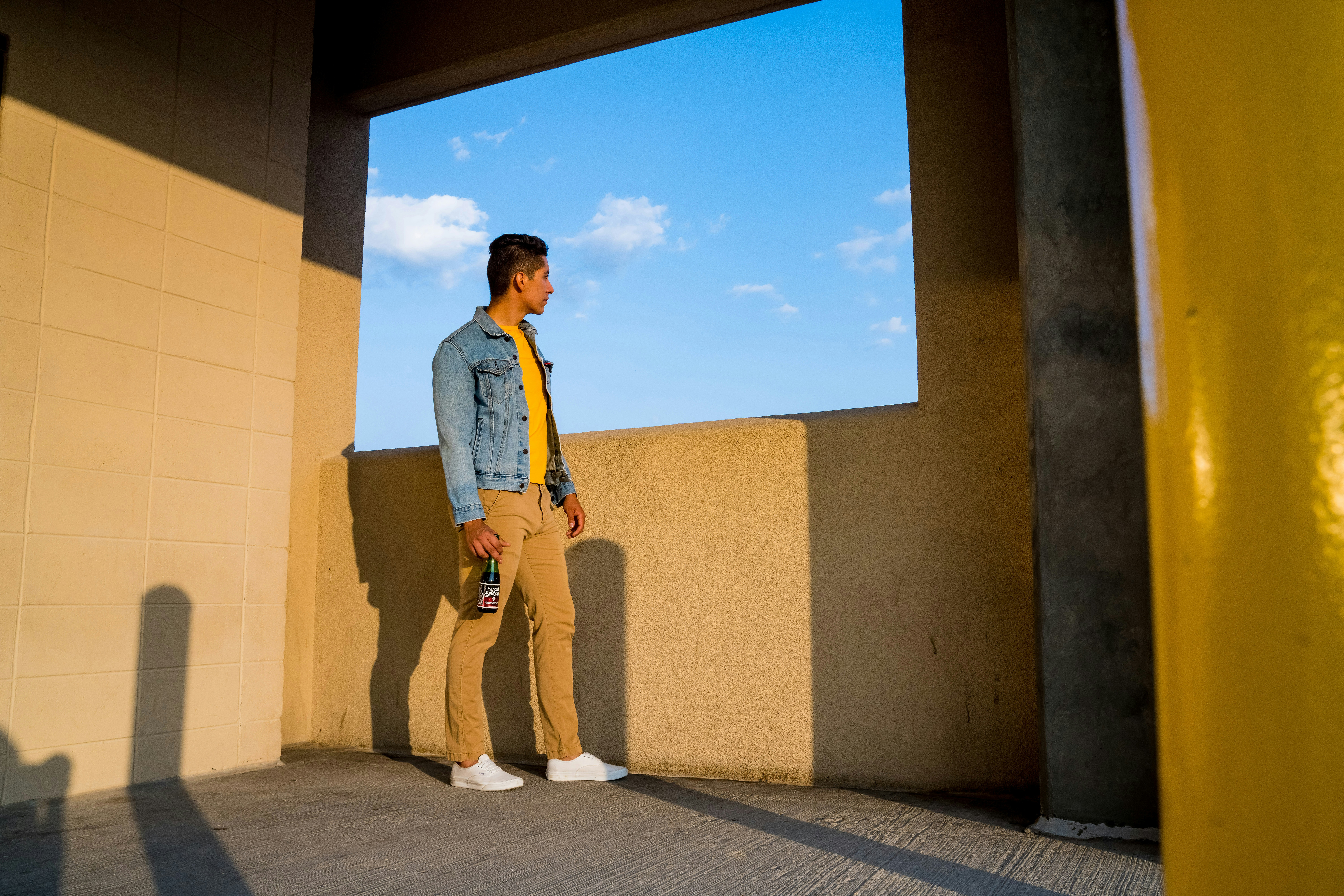 Denim-Clad Wanderer in a Sunlit Concrete Aperture