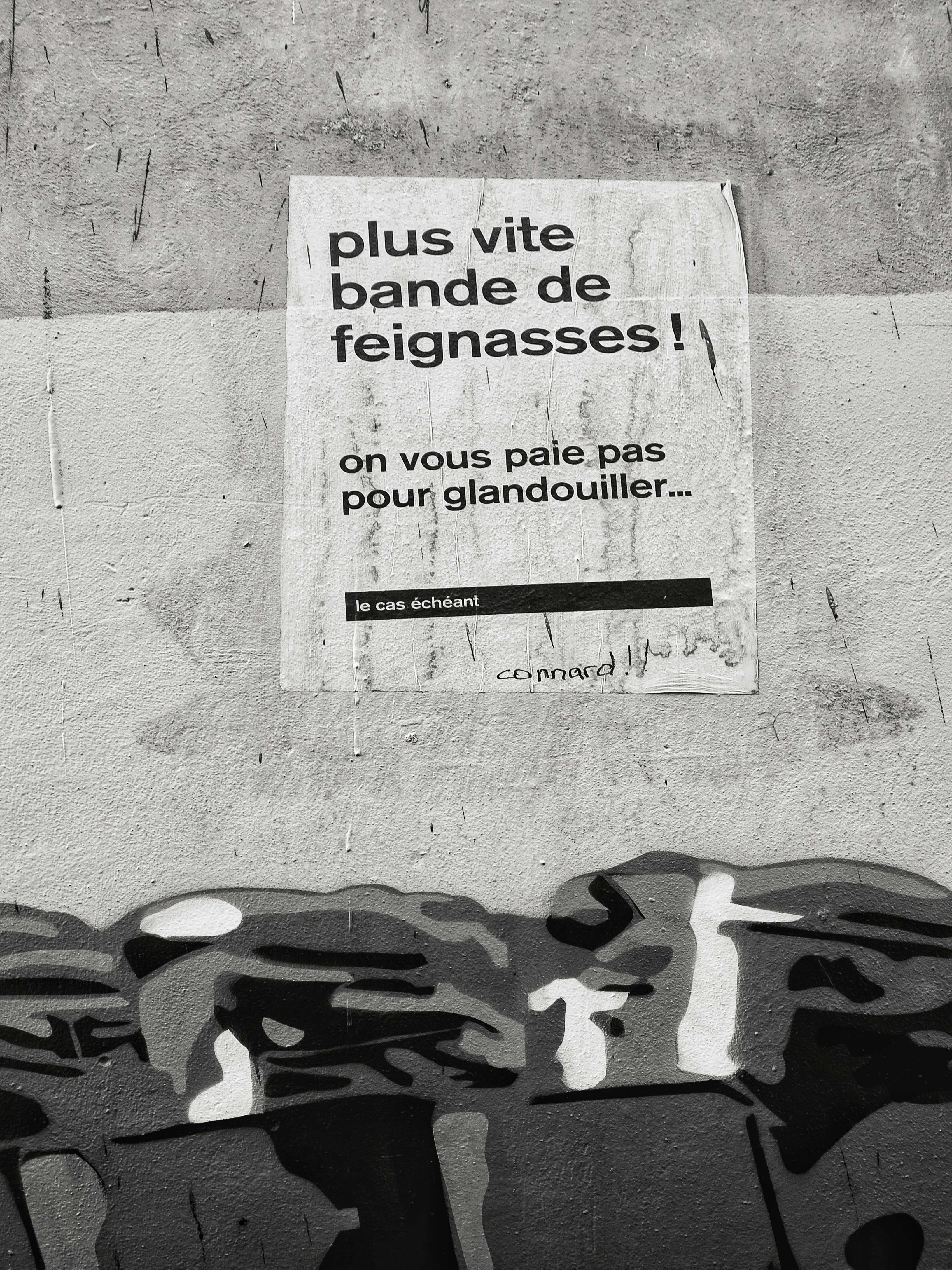 A provocative poster urging urgency and productivity, juxtaposed against a colorful graffiti backdrop in black and white.