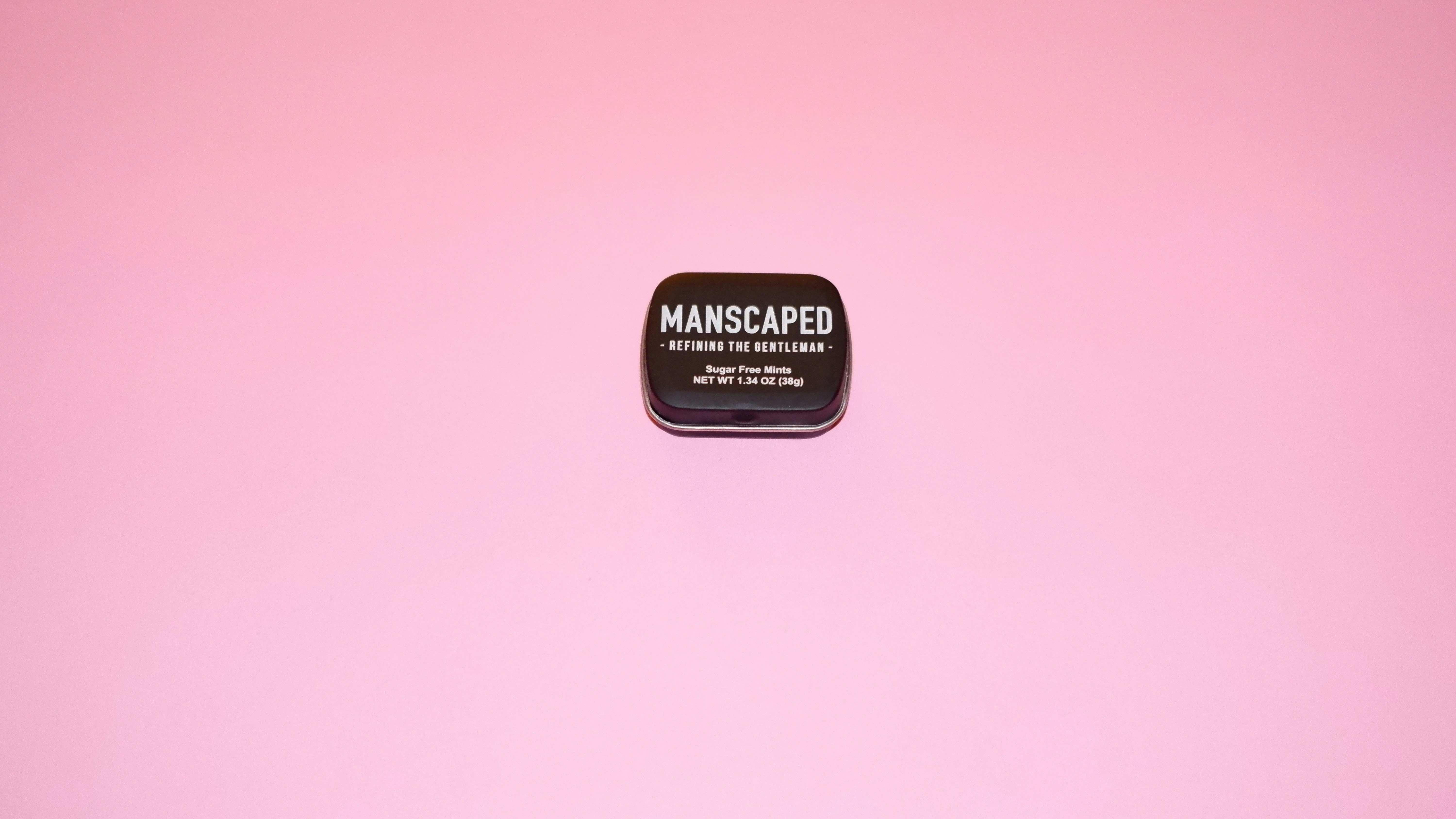 A pink background with a black and white square shaped object photo ...