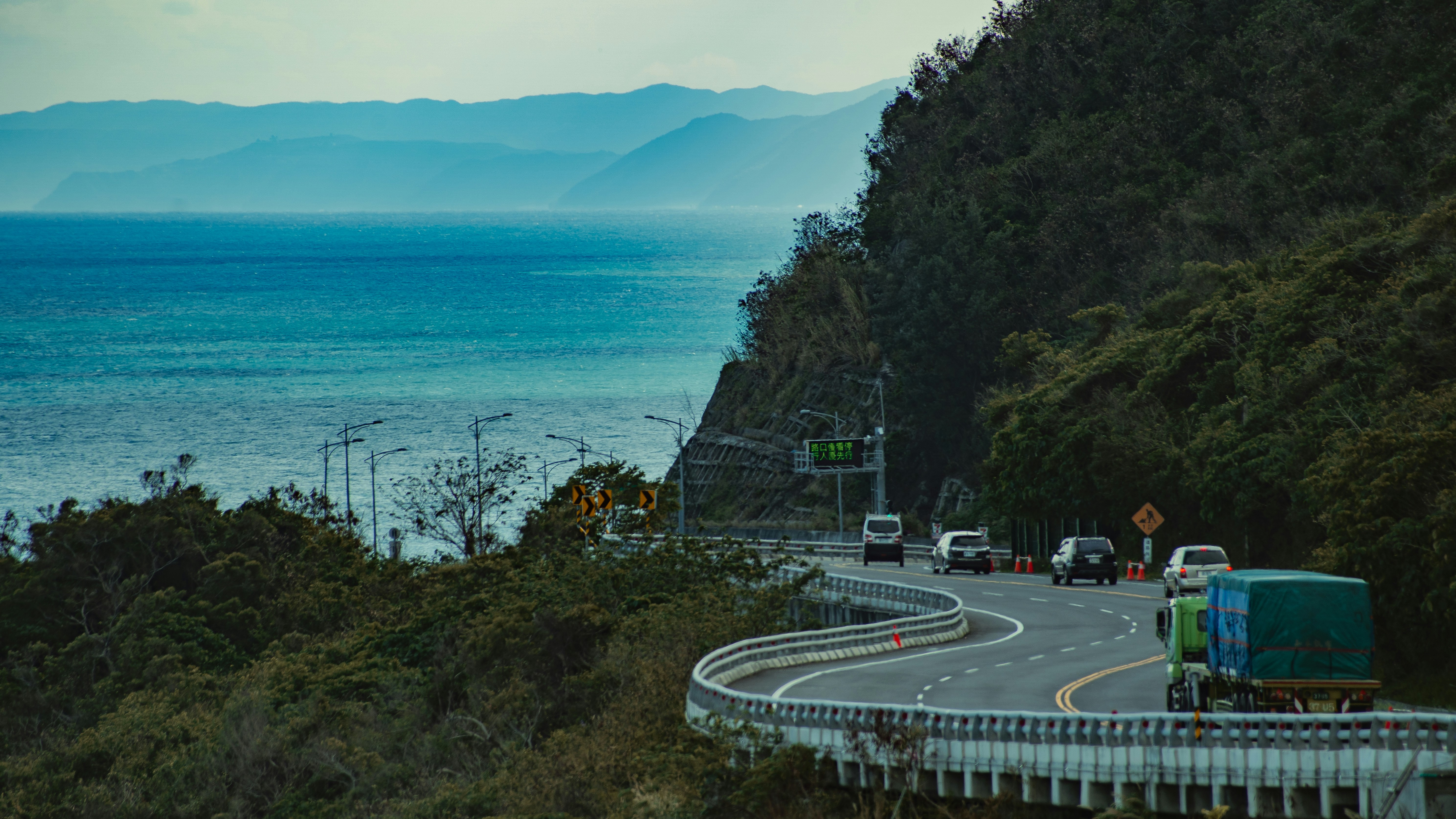 Coastal Curve: A Serpentine Highway Along Misty Sea Cliffs