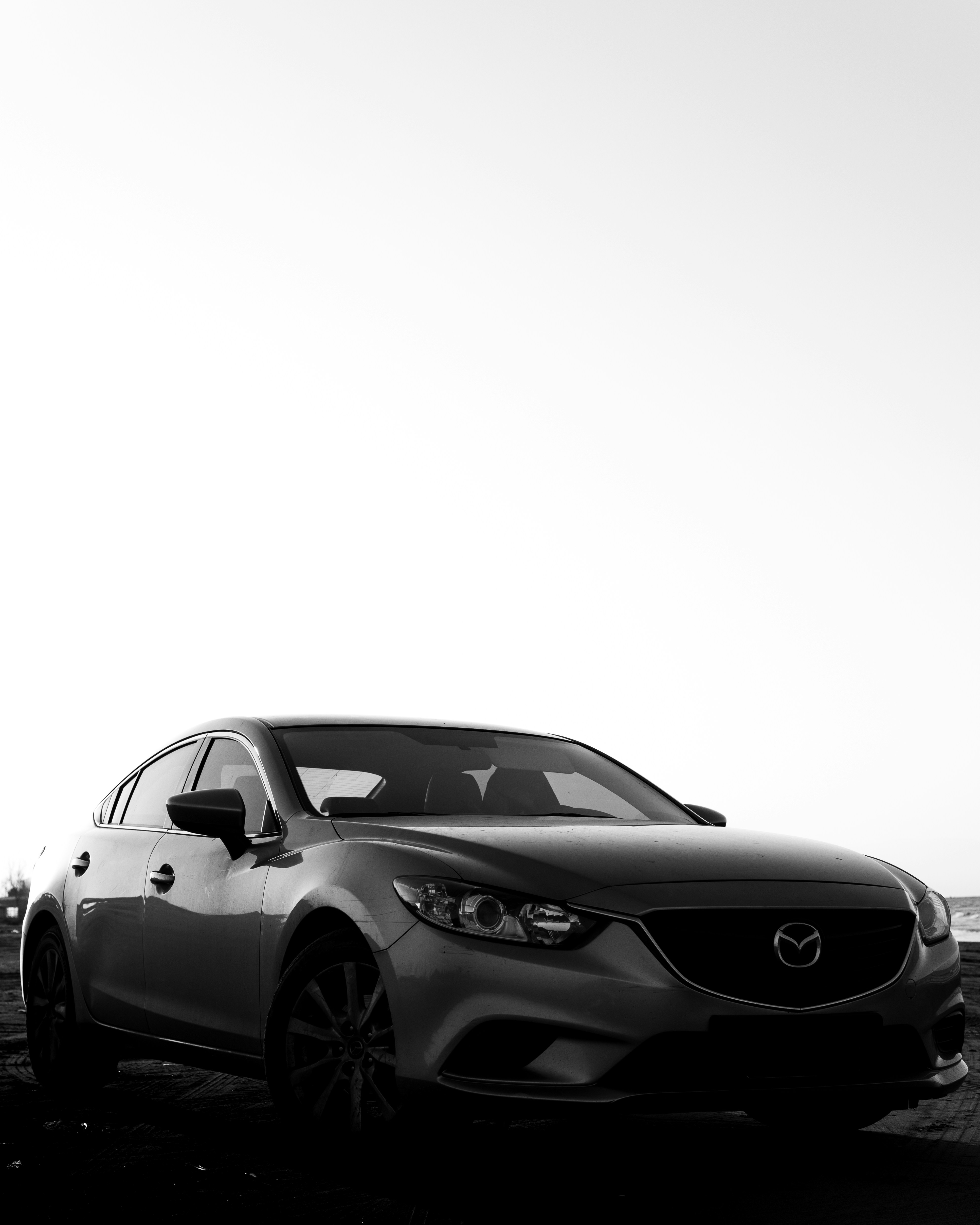 Monochrome Momentum: A Low-Angle Mazda Portrait Under a Bright Sky