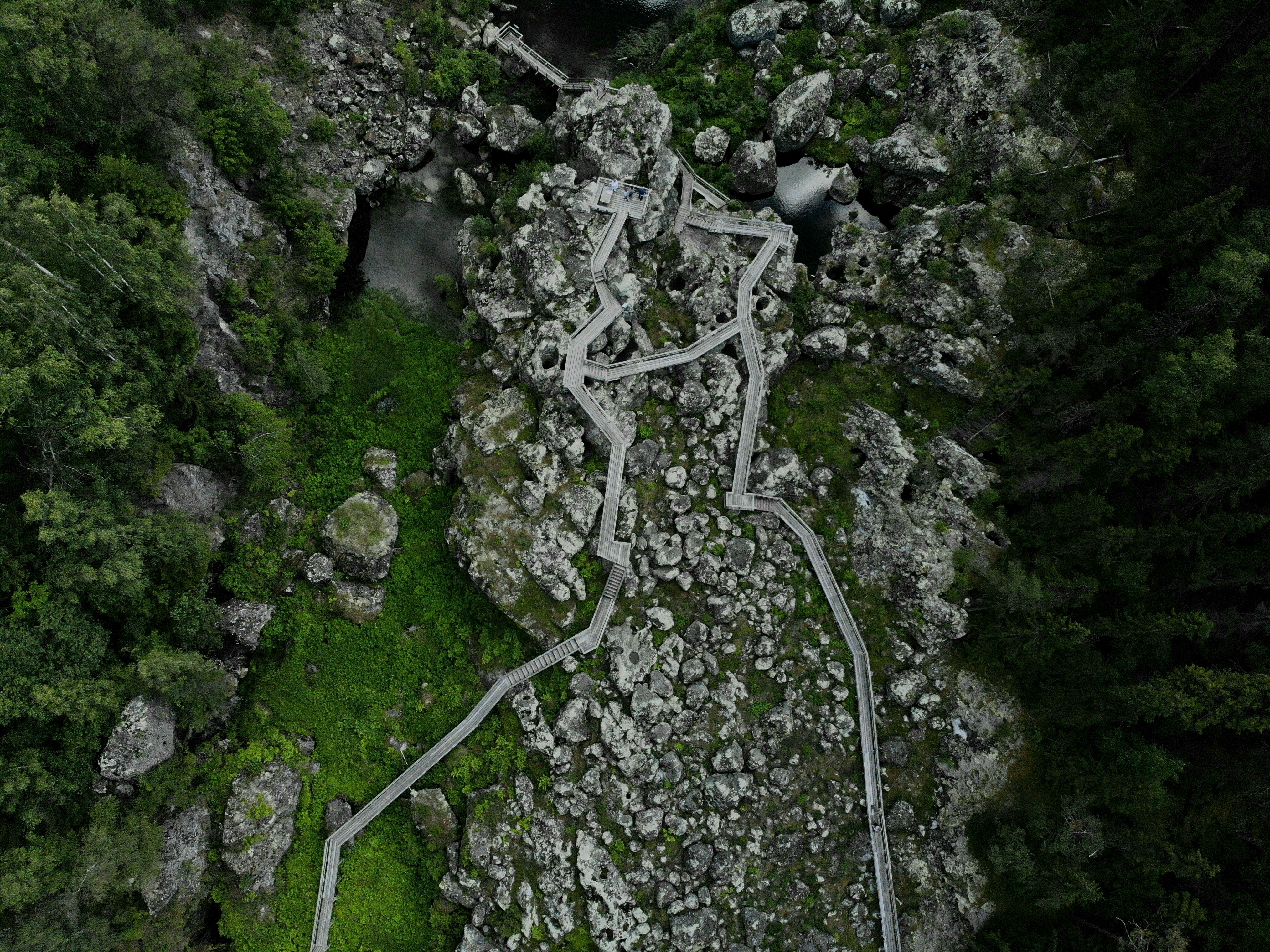 Winding Staircase Through a Mossy Rock Gorge — A Drone Portrait