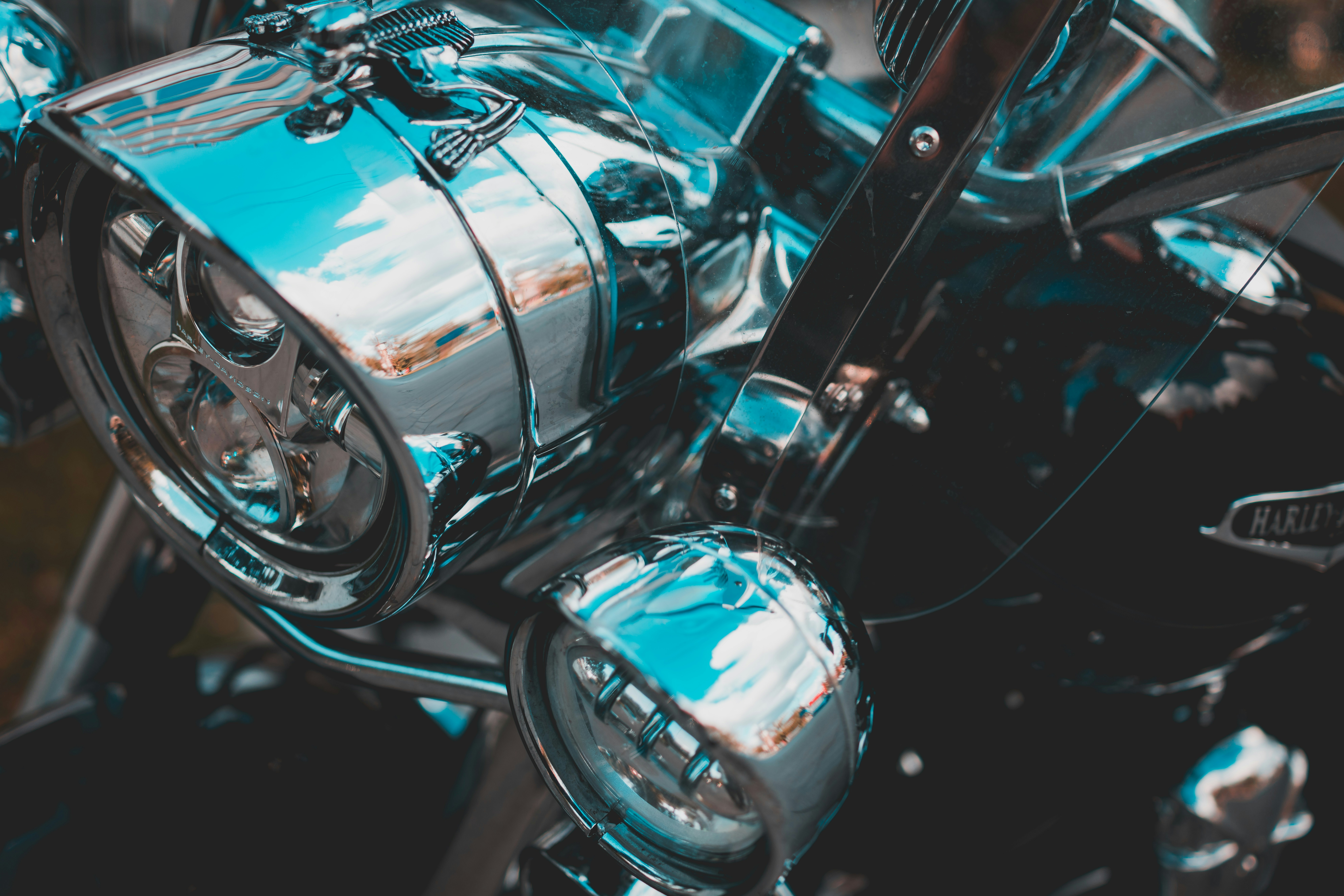 Chrome Rendezvous: Close-Up on a Motorcycle Headlamp and Reflections