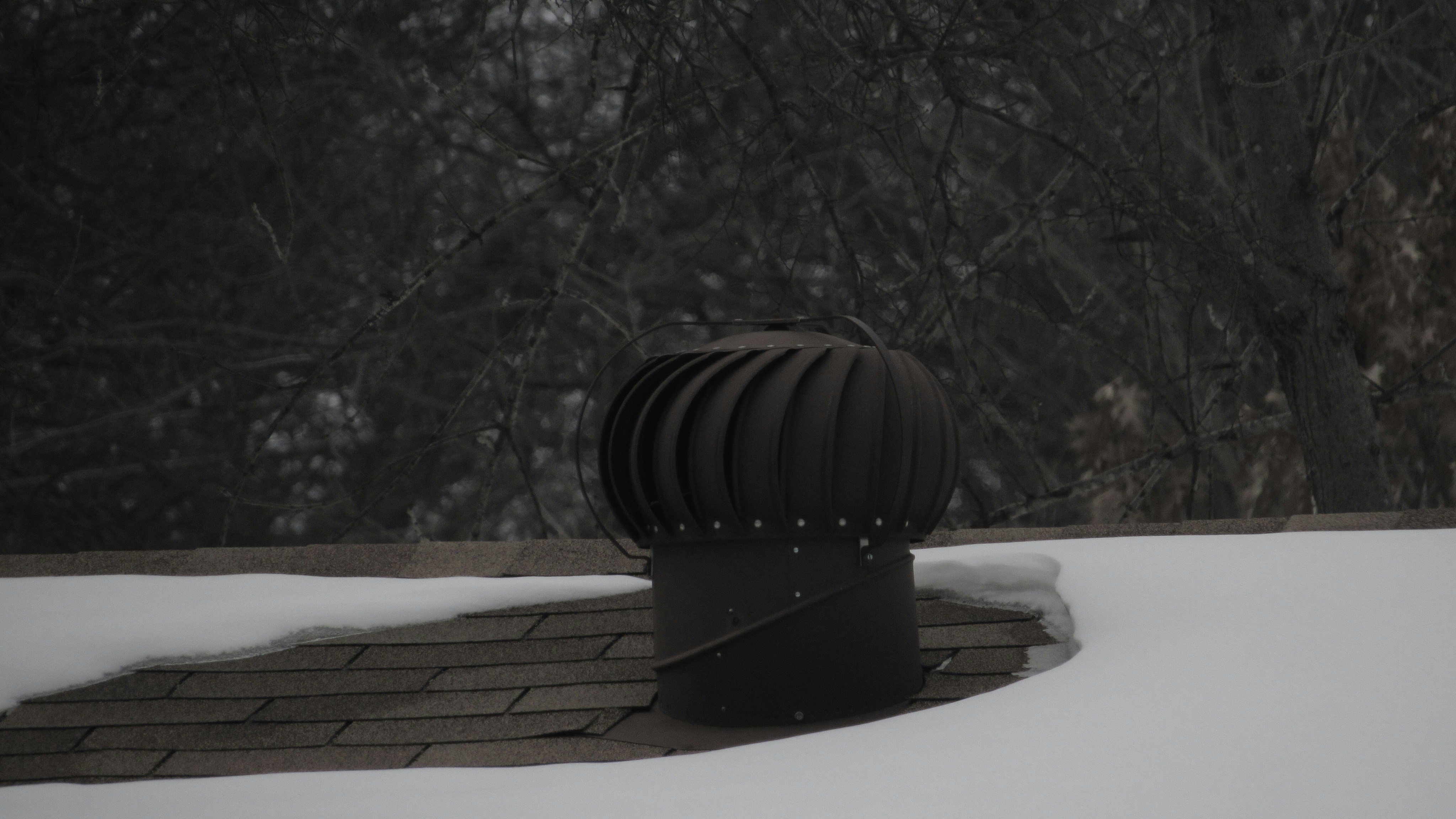 Coiled Rooftop Vent in Quiet Winter Snow