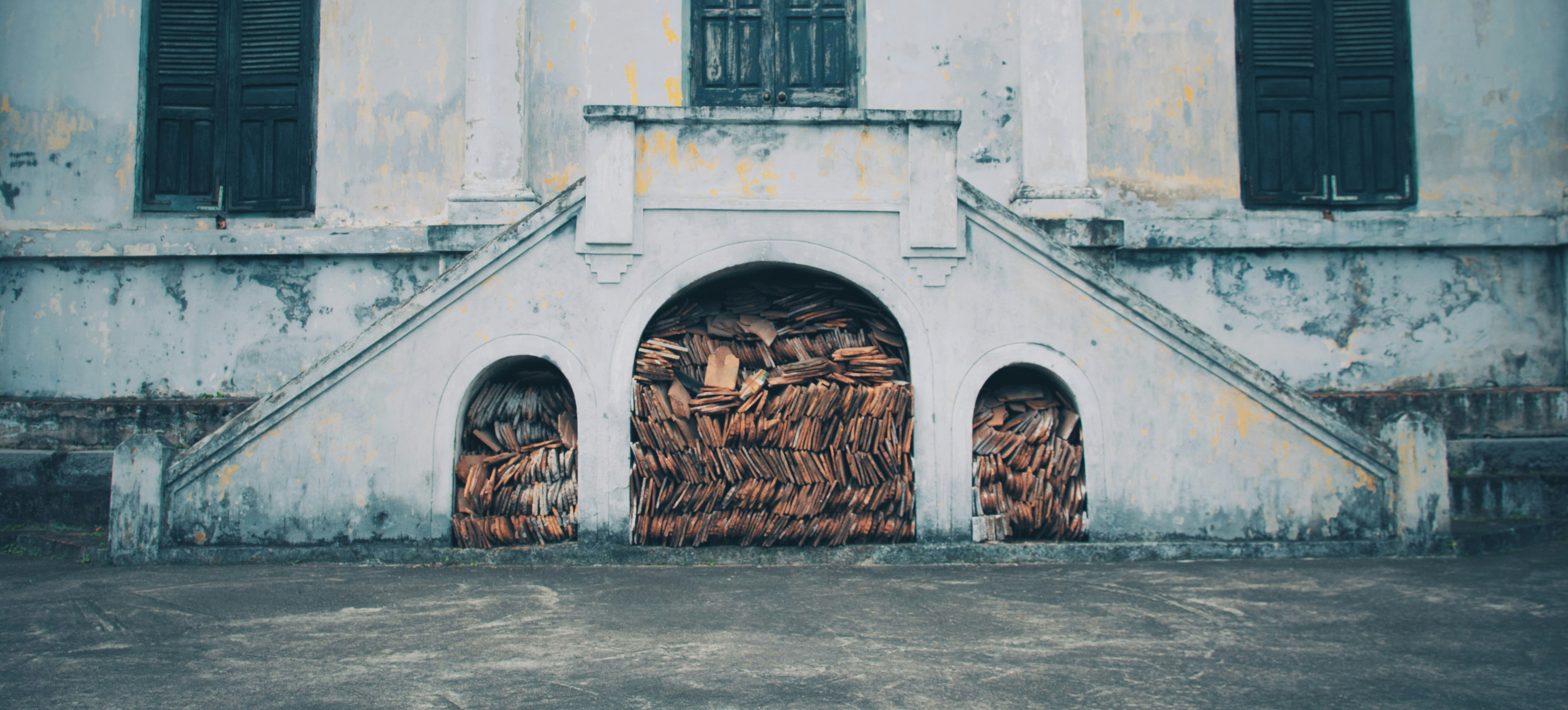 Stacks of Firewood Framed by an Aged Archway