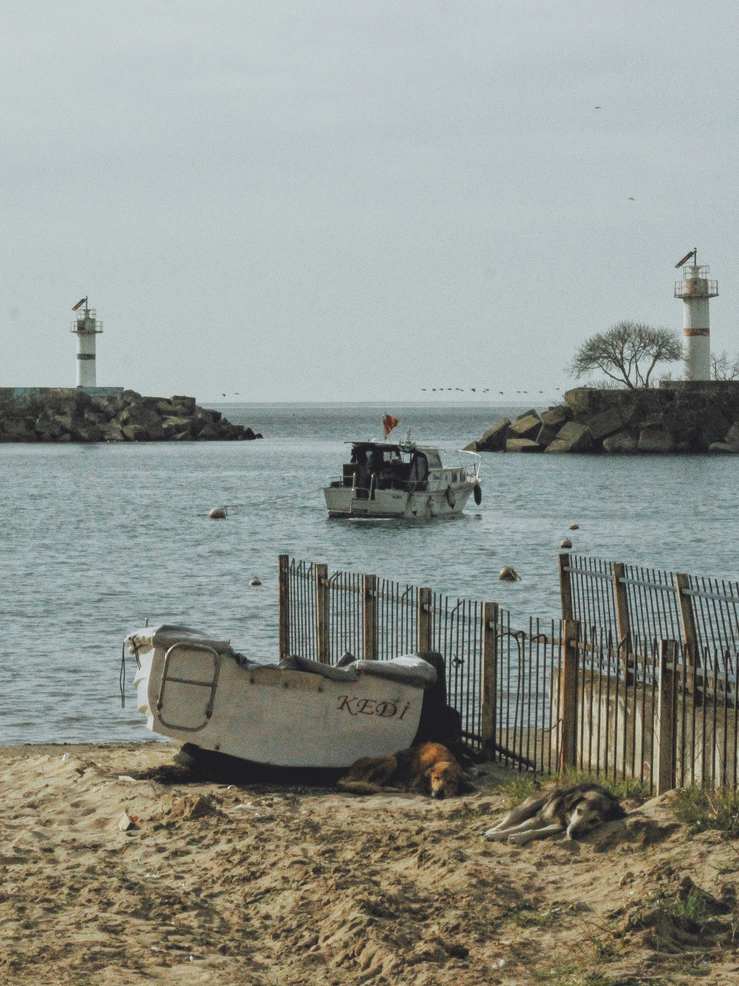 Calm Channel Approach: A Small Boat Between Twin Lighthouses