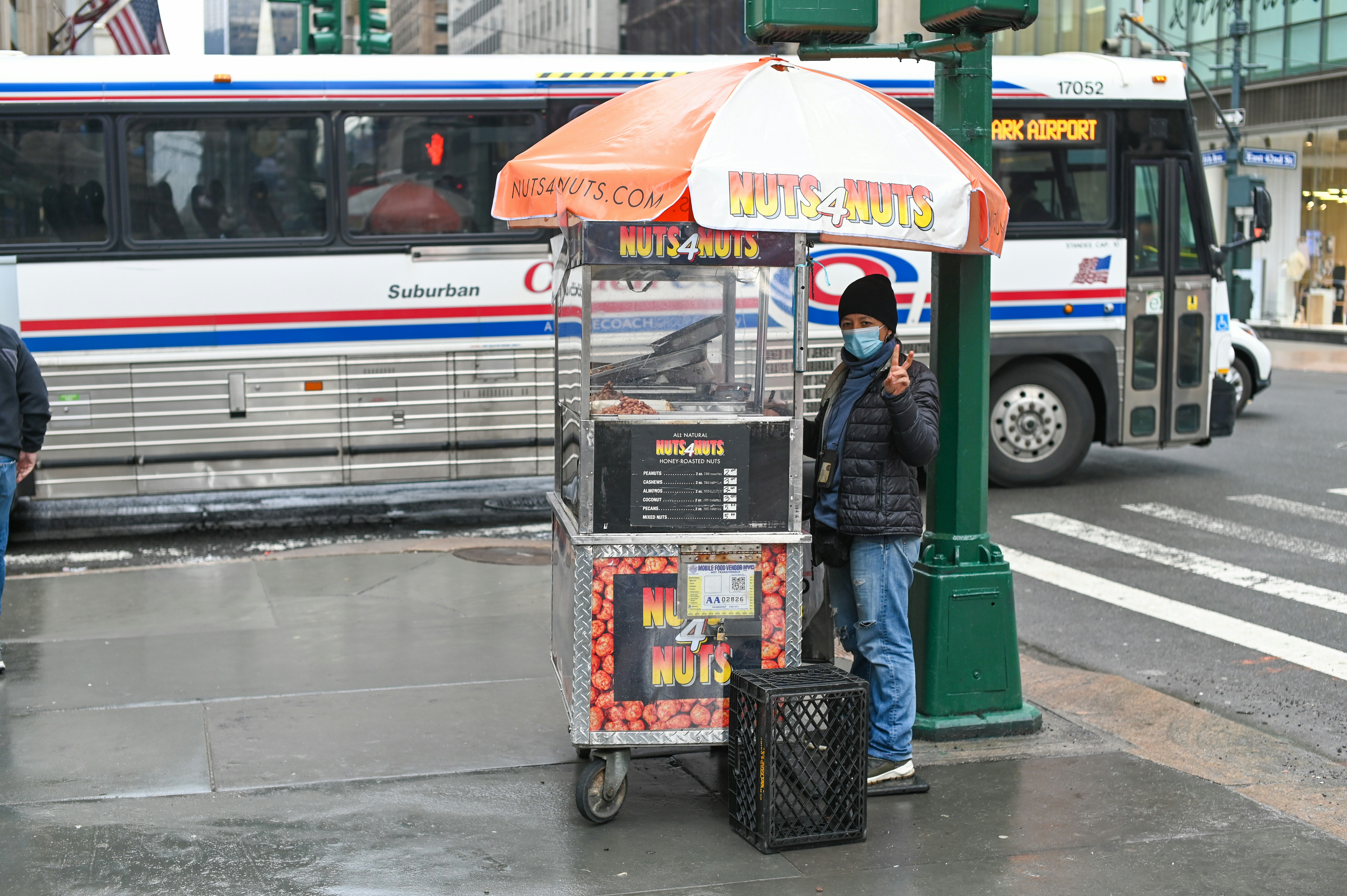 Rain-kissed Corner: Nuts for Sale Under an Orange Canopy