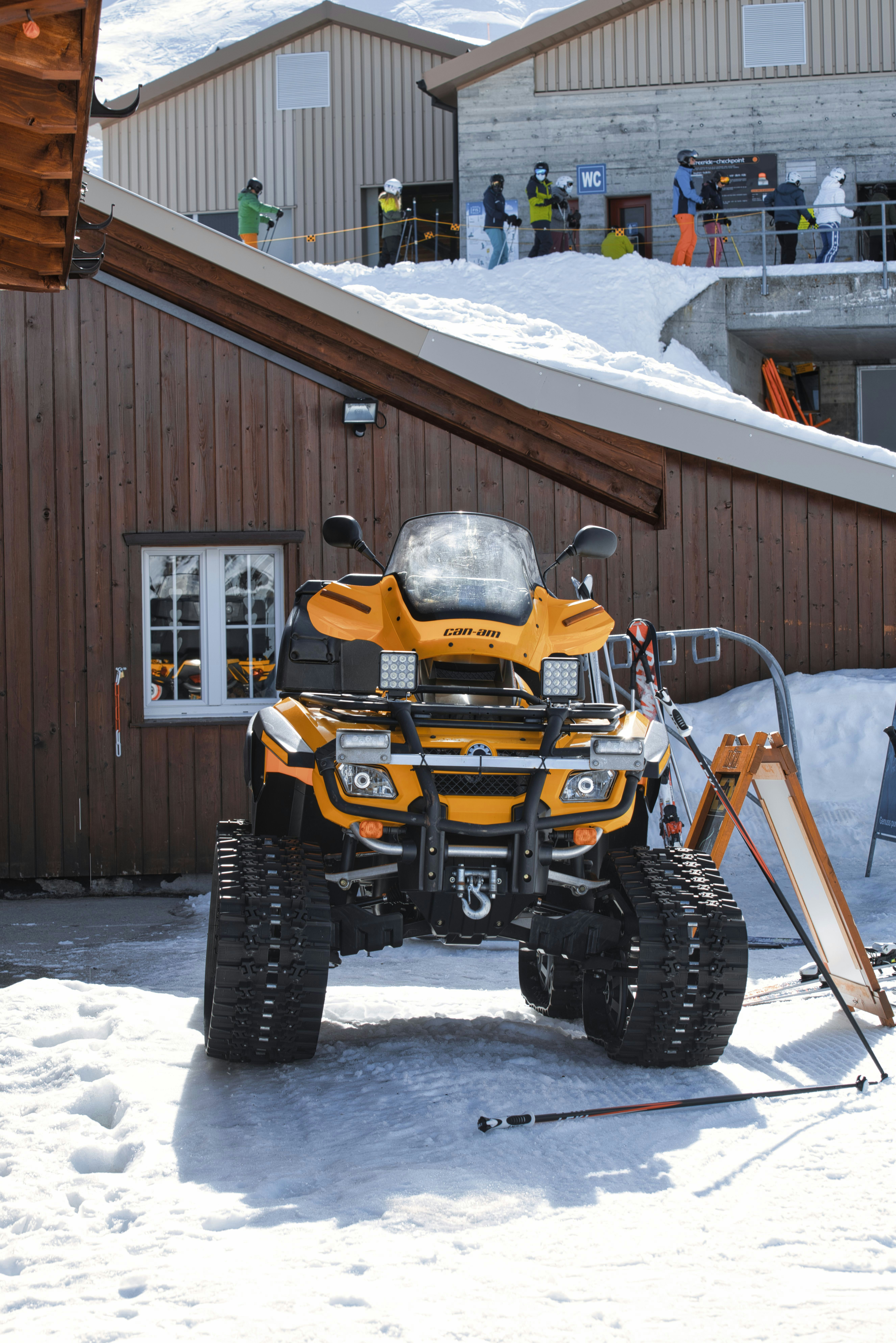 Yellow and black atv on snow covered ground photo – Free Human Image on ...