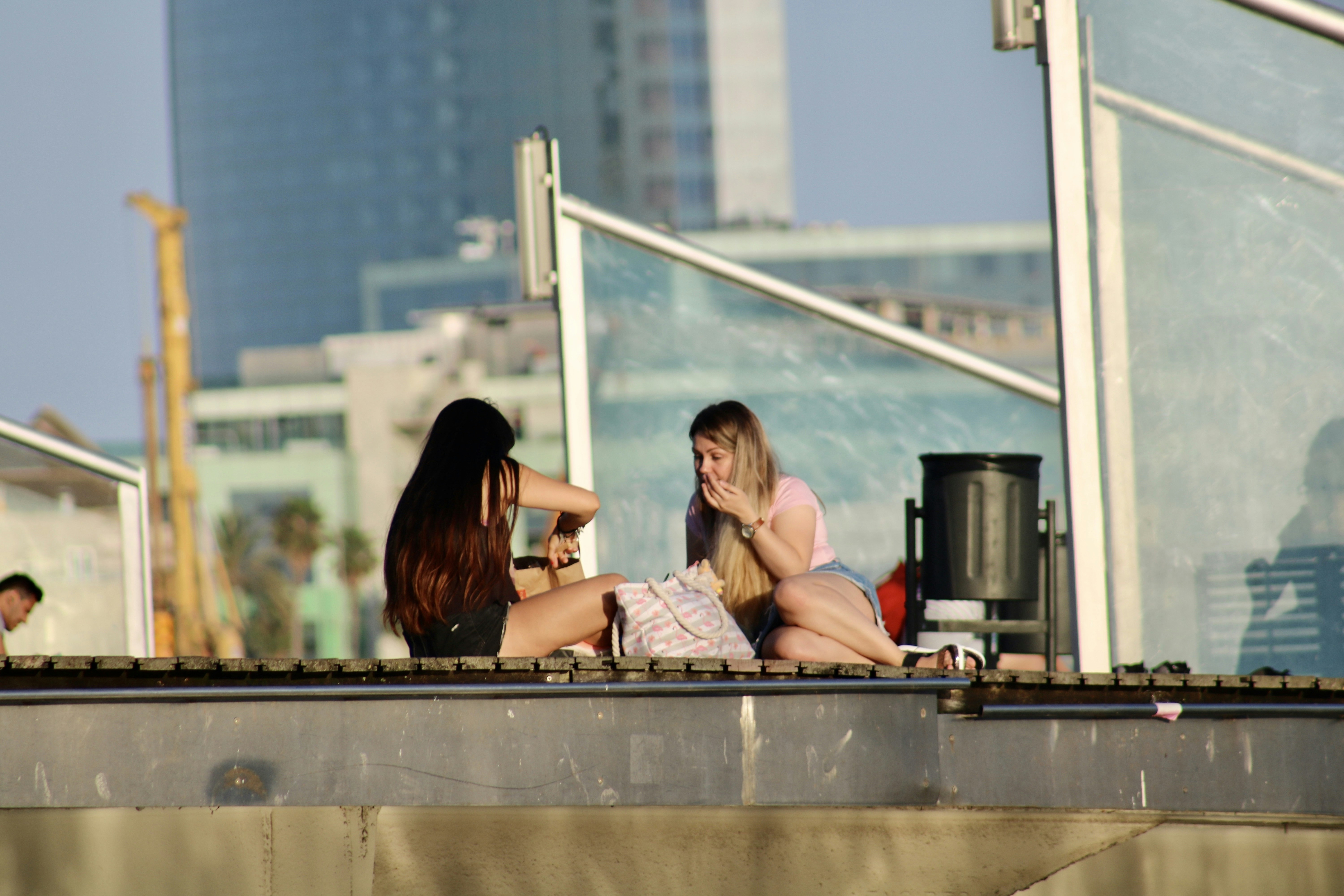 Conversations on the Edge: Friends in a Sunny Rooftop Moment
