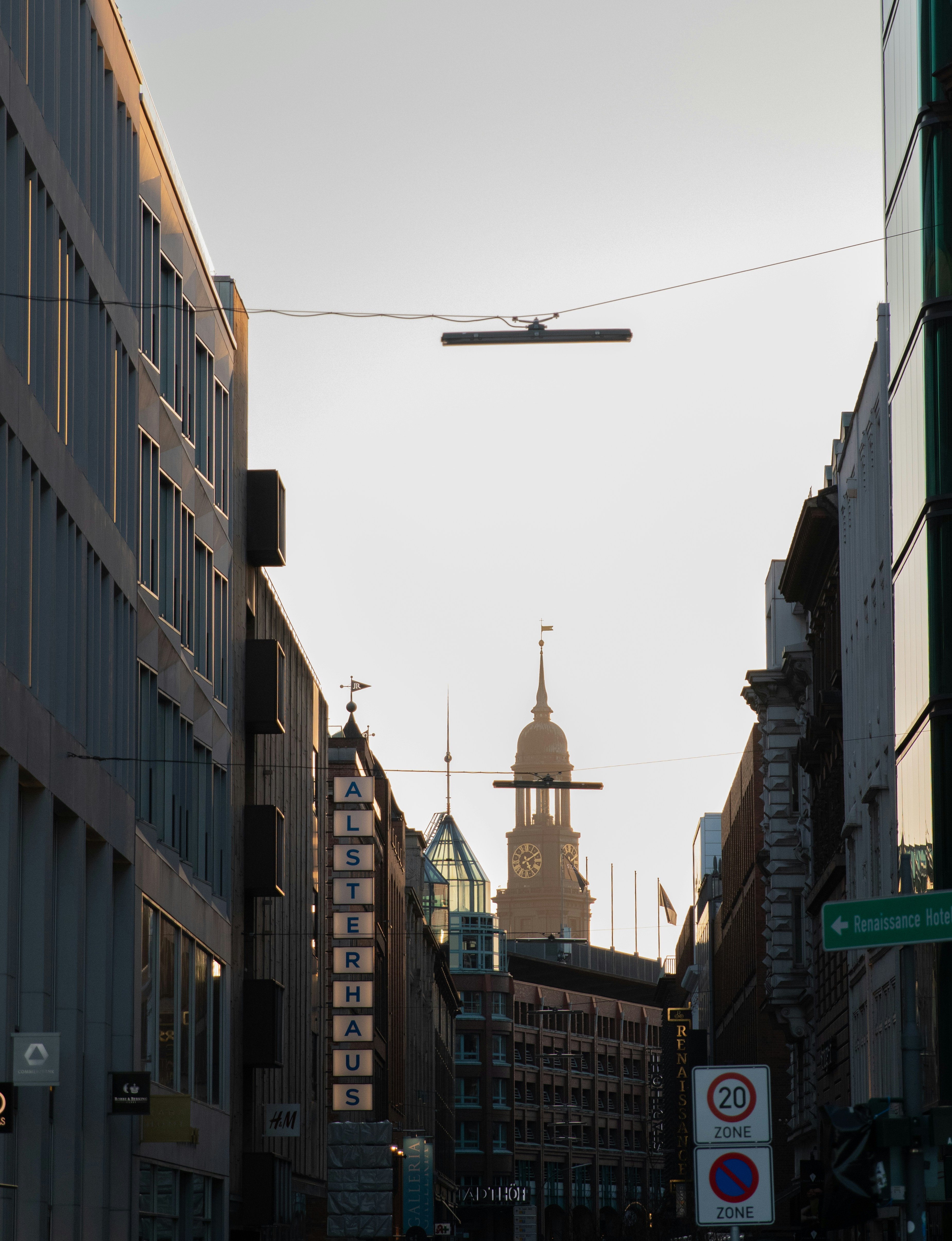 Timekeeper Over the Urban Canyon: Clock Tower Rising Between Narrow Streets