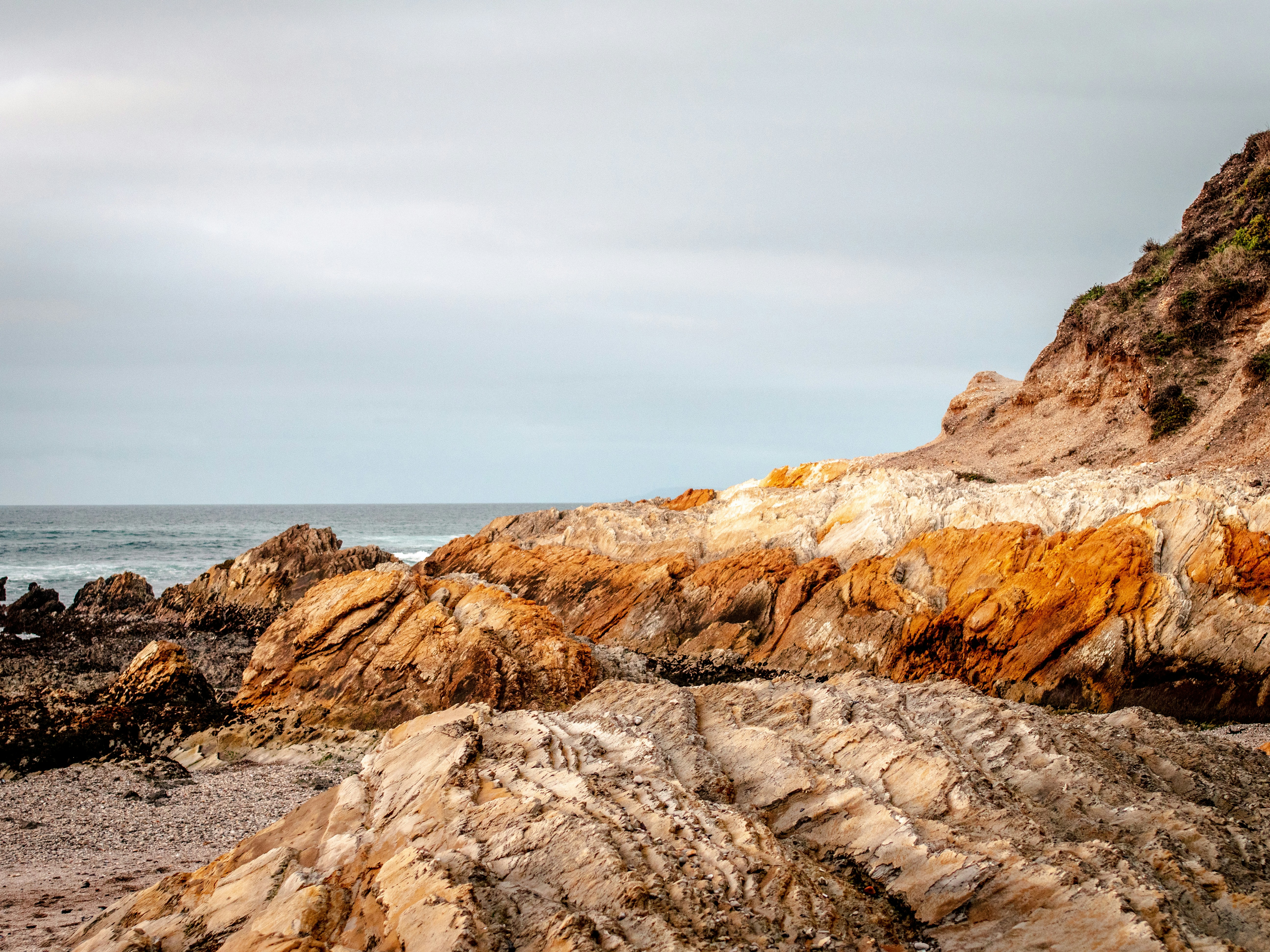 Coastal Rock Fractures Emitting Autumn Light